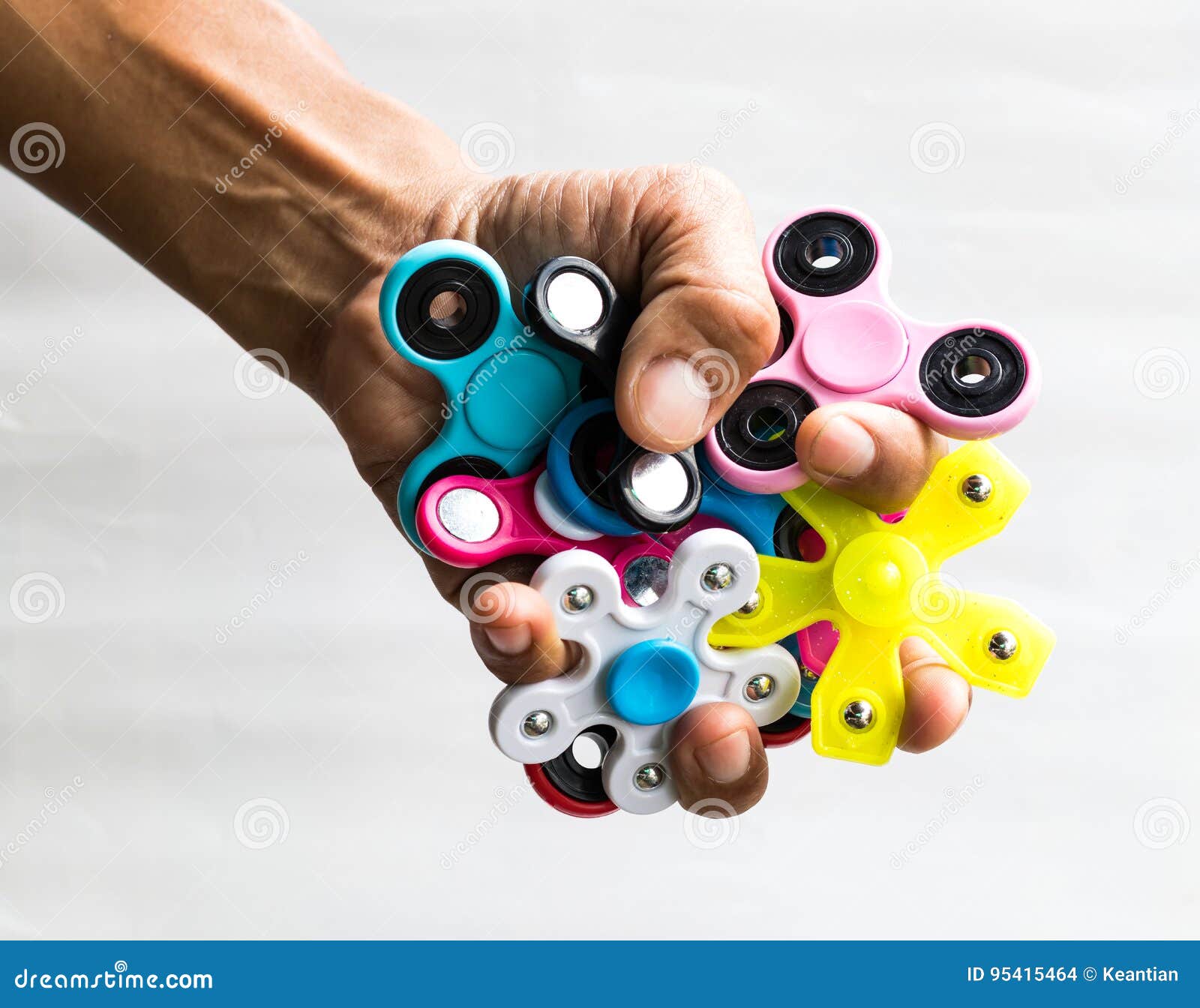 Hand spinners in hand. stock photo. Image of green, holding - 95415464