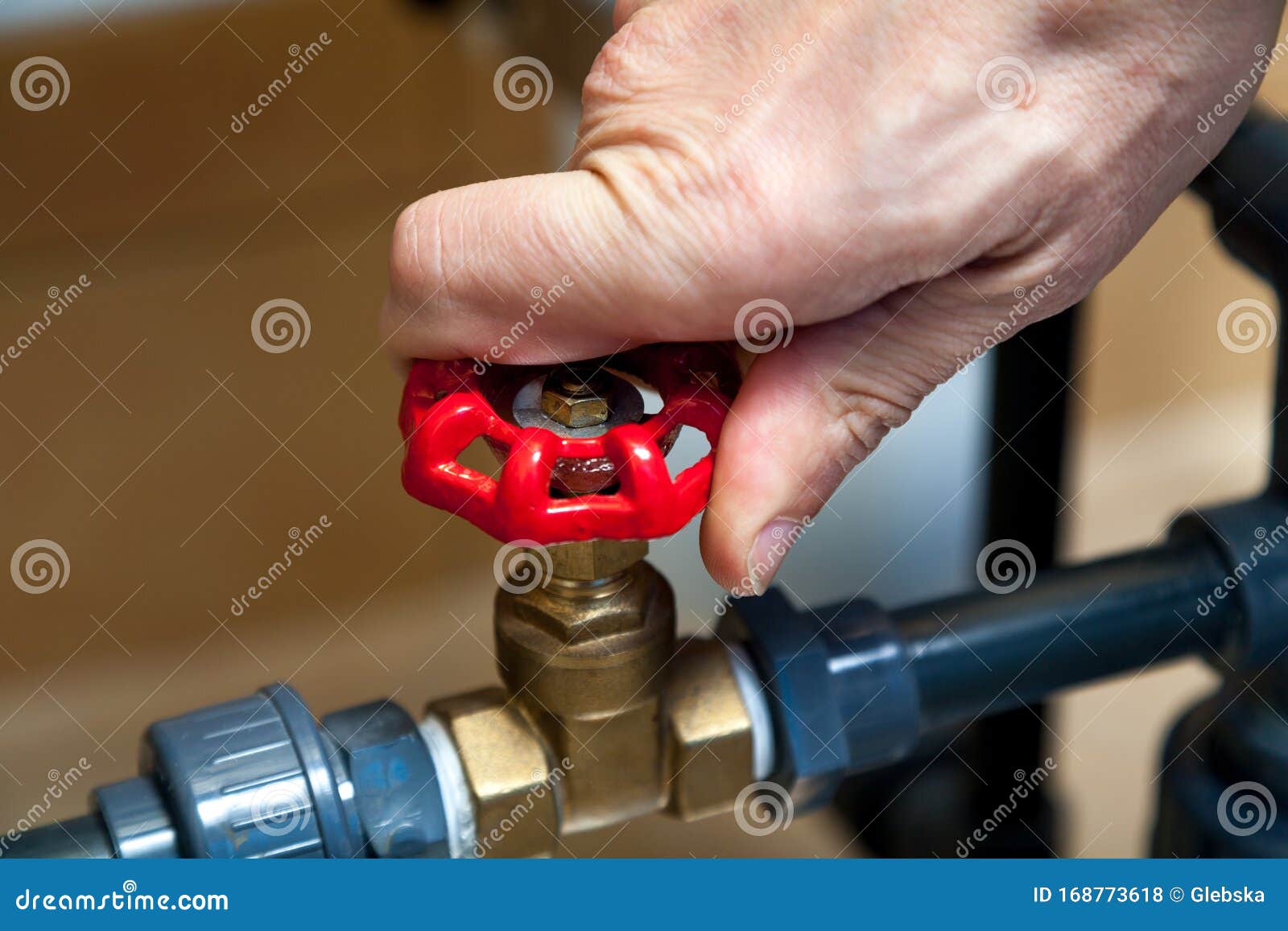 Hand spins valve close-up stock photo. Image of closeup - 168773618