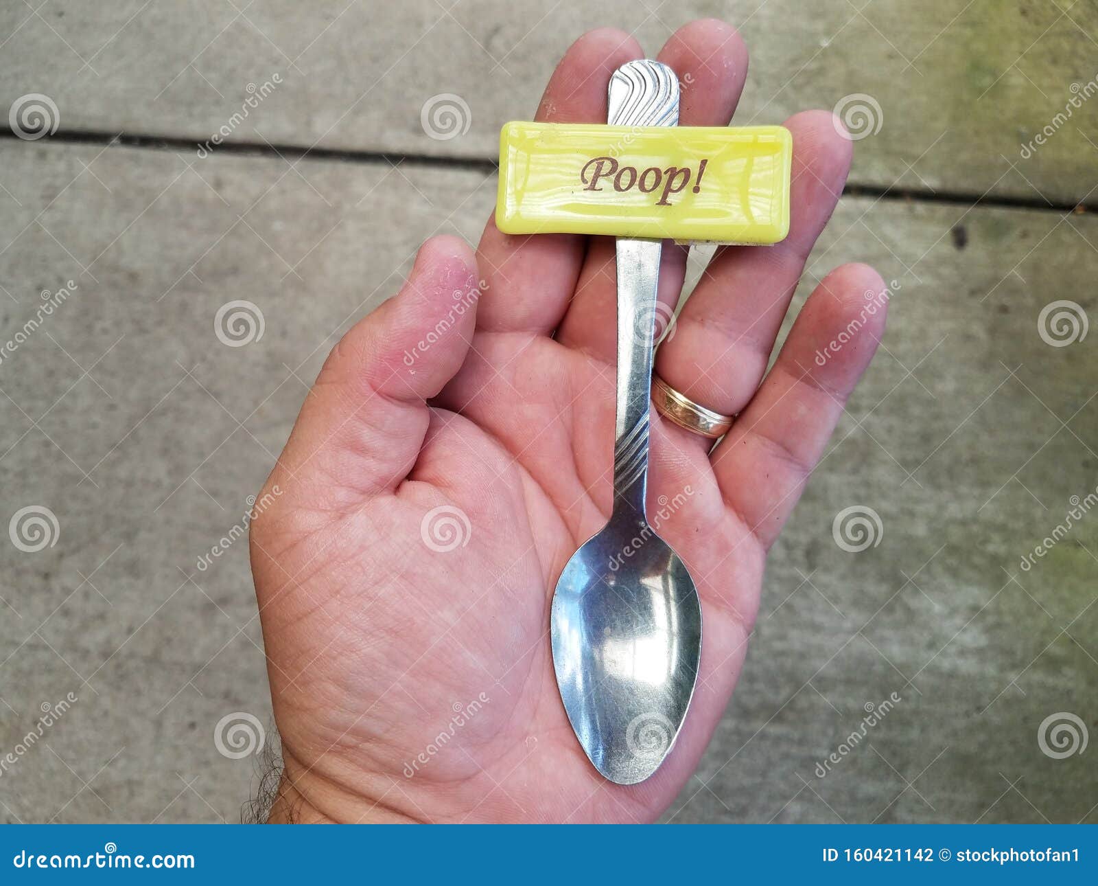 Hand with Spoon and Poop Sign and Gold Ring Stock Photo - Image of sign ...