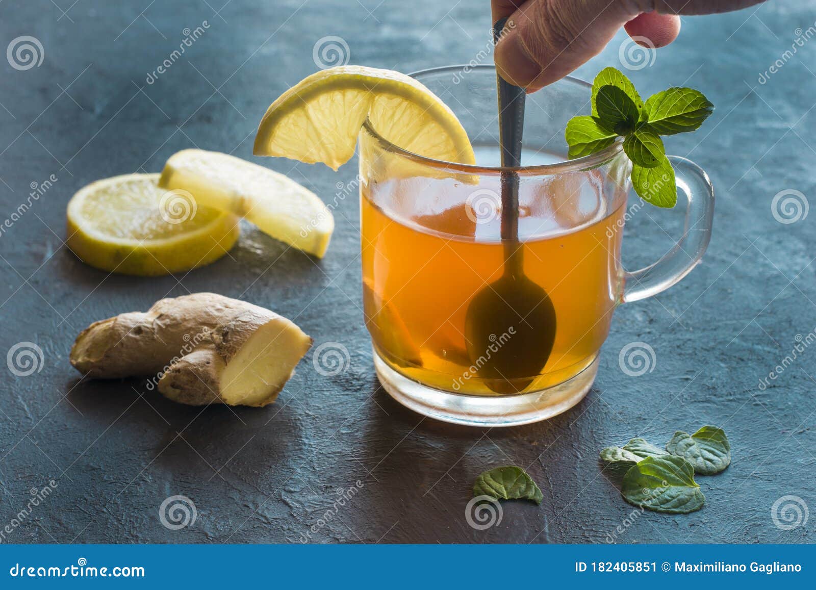 A Hand with a Spoon Stirring into a Cup of Ginger Tea Stock Image ...
