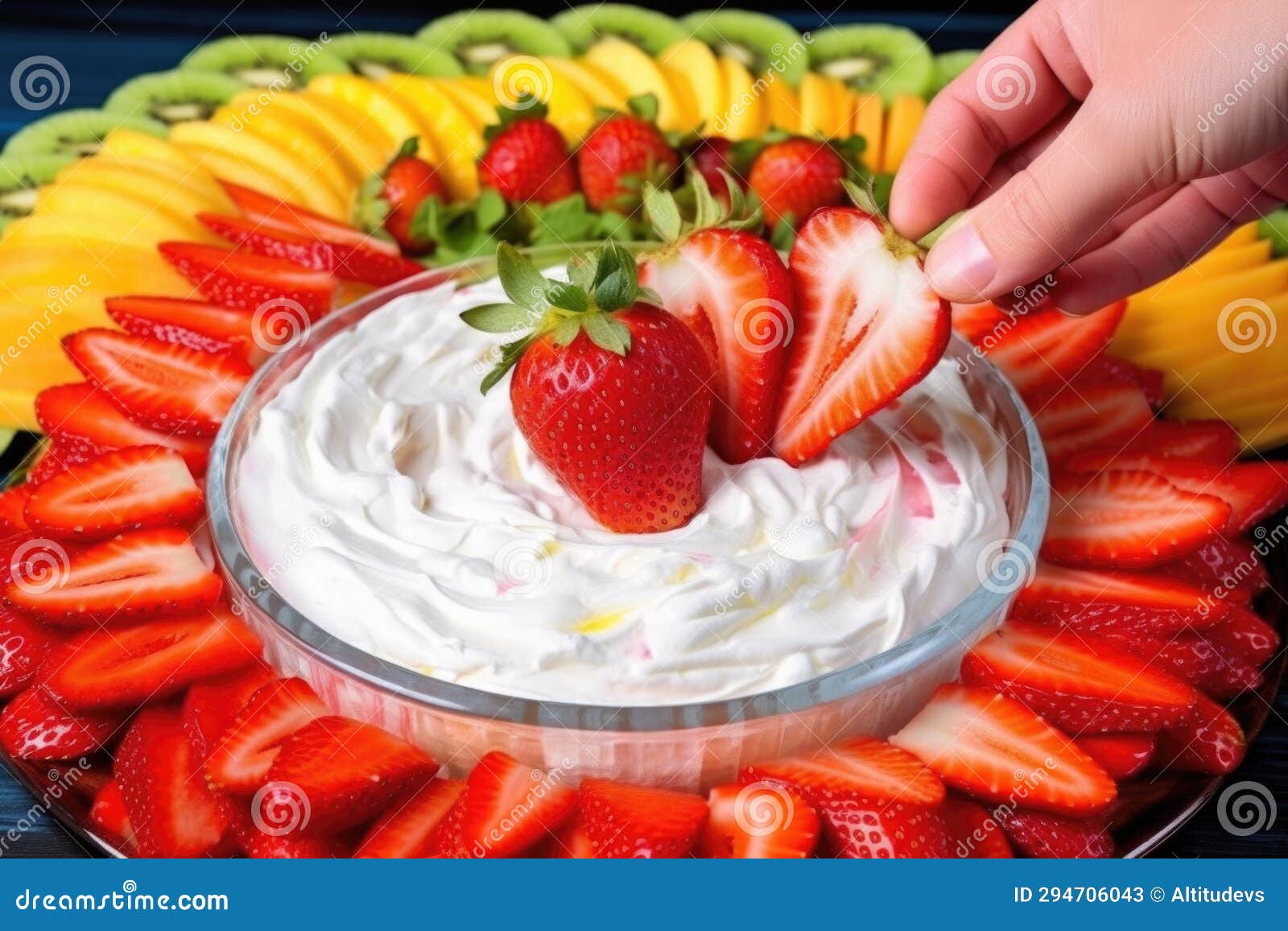 Hand Spreading a Layer of Whipped Cream on a Strawberry from a Bright ...