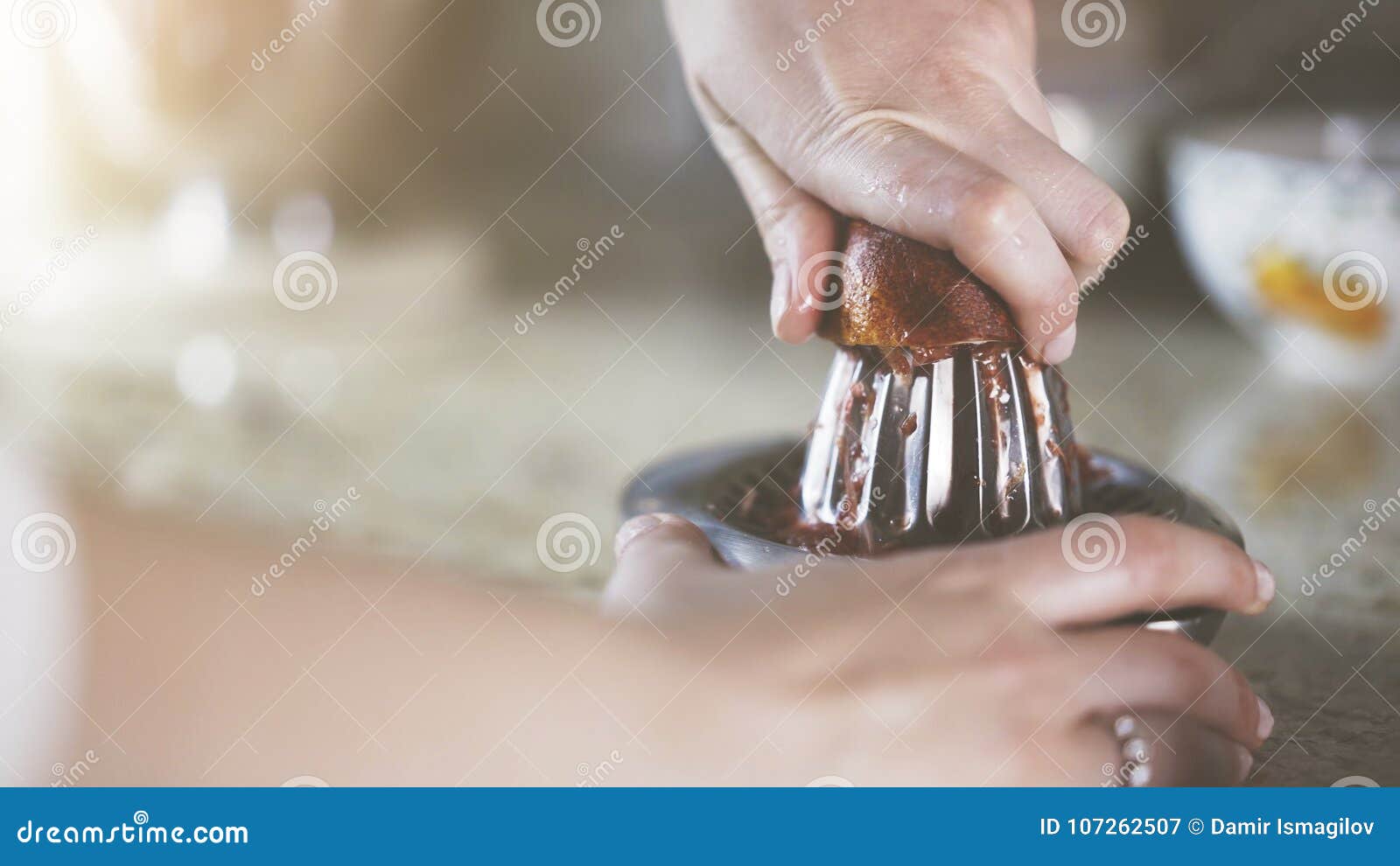 A Hand Squeezing Juice from an Orange on a Manual Glass Squeezer. Stock ...