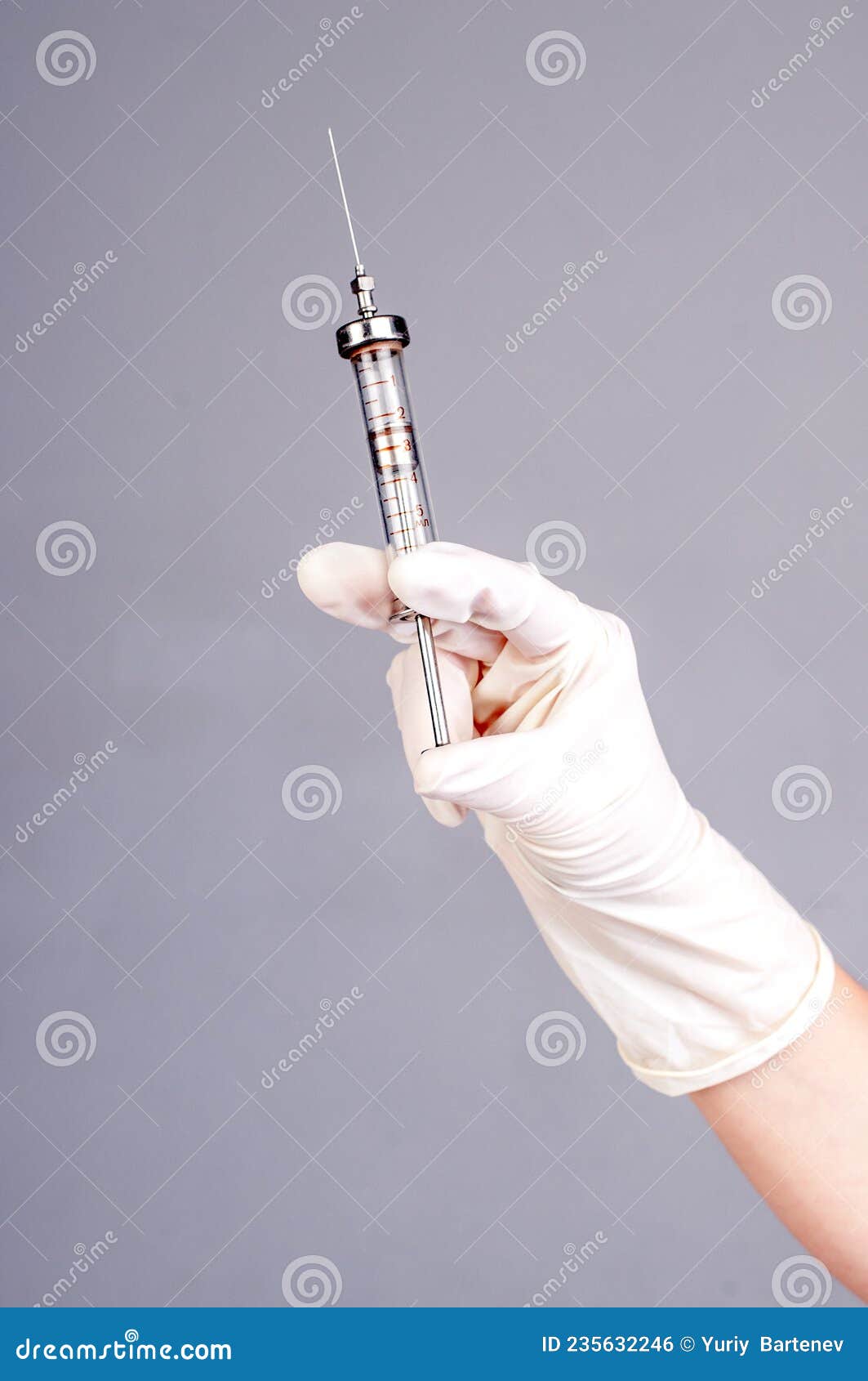 Hand Squeezing an Old Glass Syringe with a Sharp Needle. Stock Photo ...