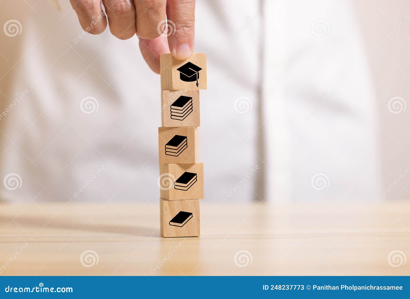 Hand Stack Wooden Blocks with Book Icon To Graduate Icon. Stock Image ...