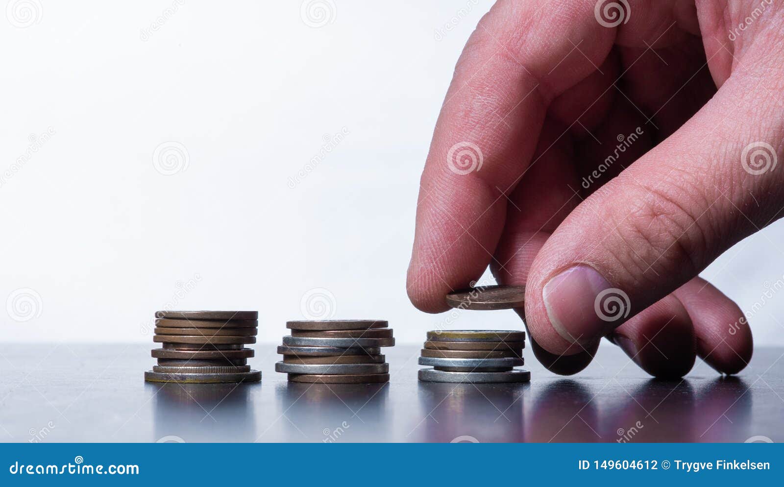 Hand Stacking Small Coins on a Table Stock Photo - Image of loan ...