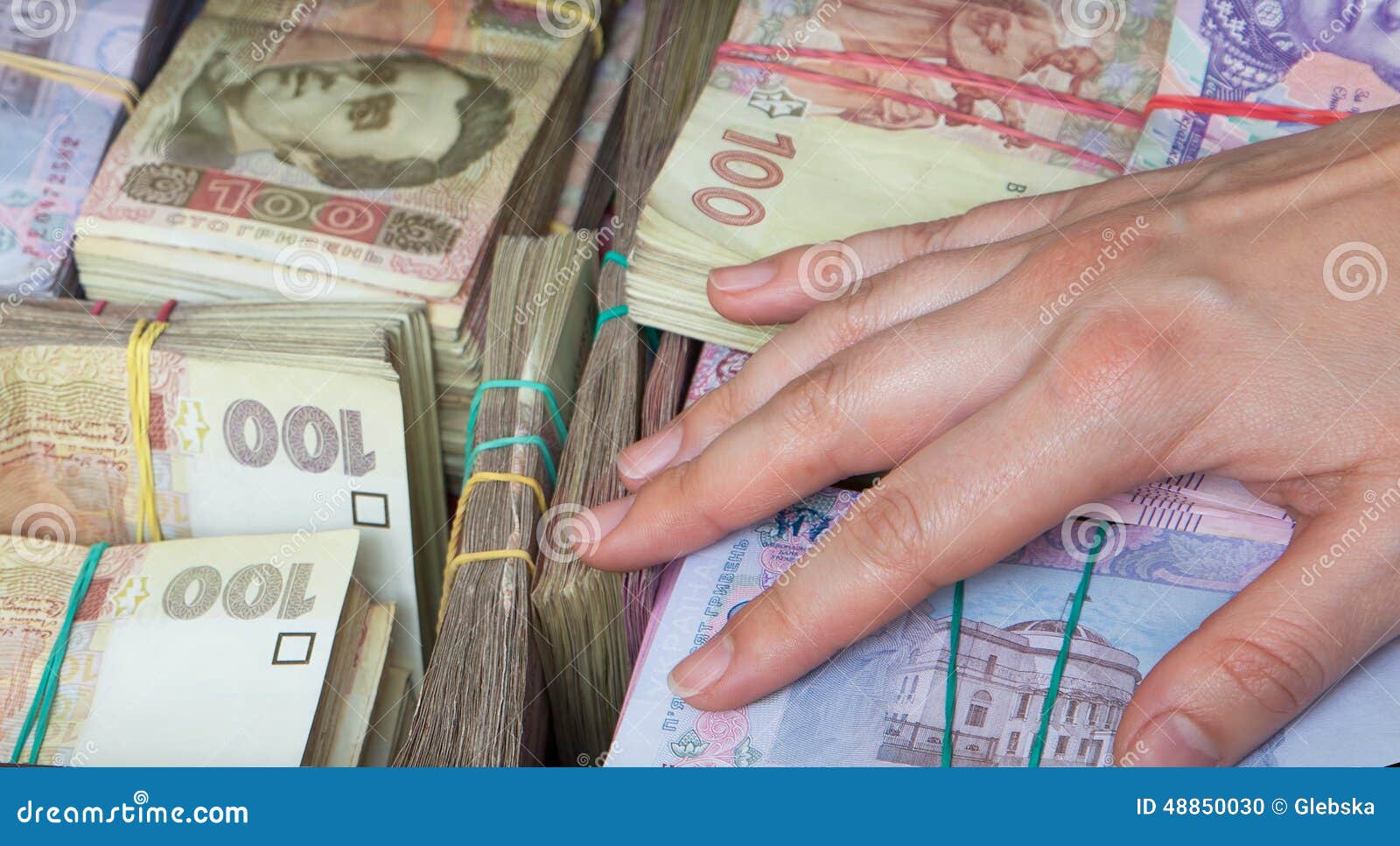 Hand on stacks of money stock photo. Image of expenses - 48850030