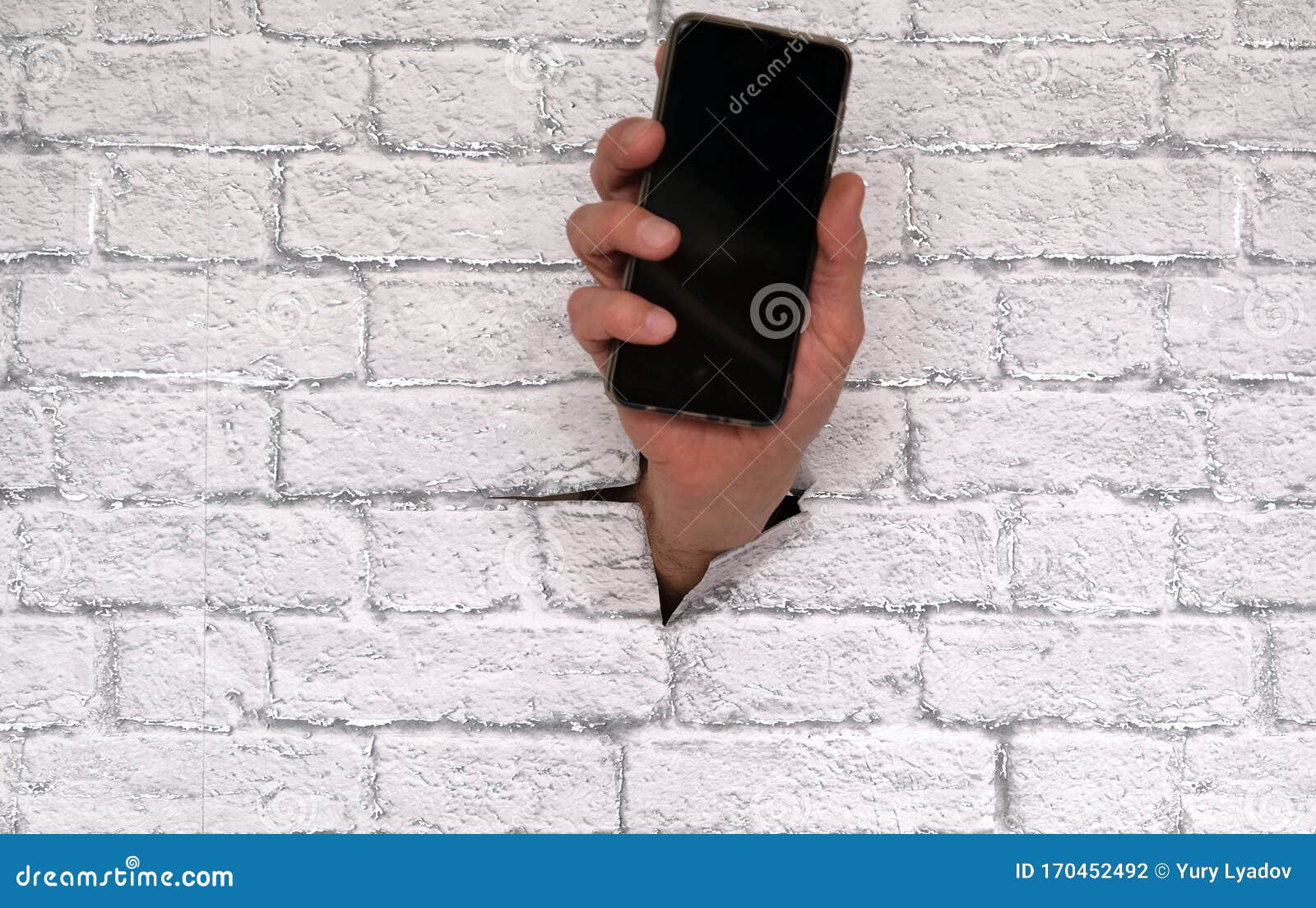 Hand Sticking Out of a Brick Wall with a Smartphone Stock Photo - Image ...