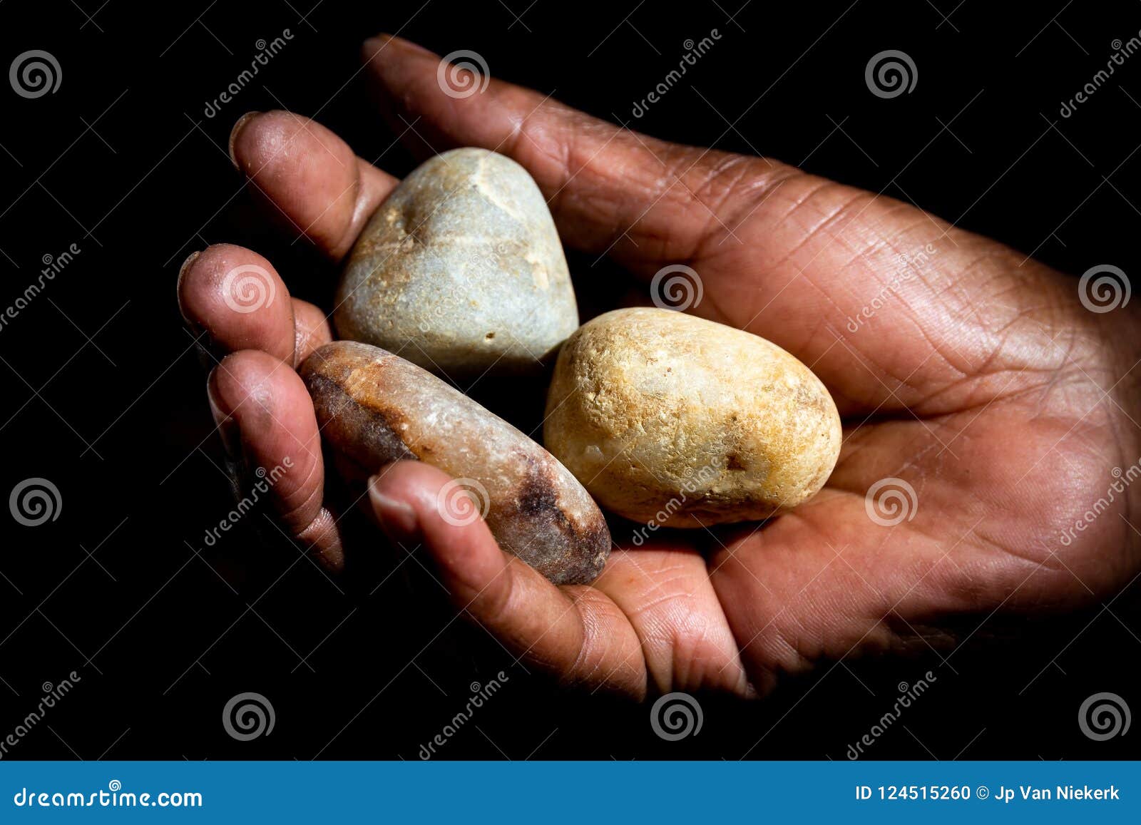 Hand and Stones stock photo. Image of three, hand, pebbles - 124515260