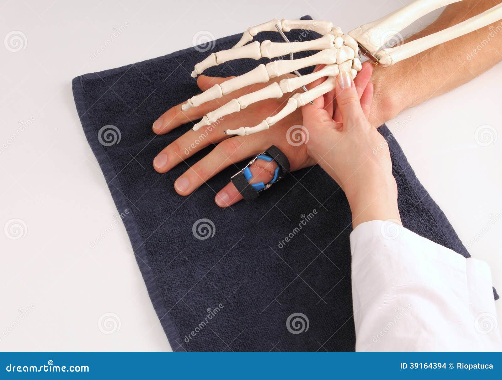 Hand Surgeon with Skeleton Hand at Patient Stock Photo - Image of ...
