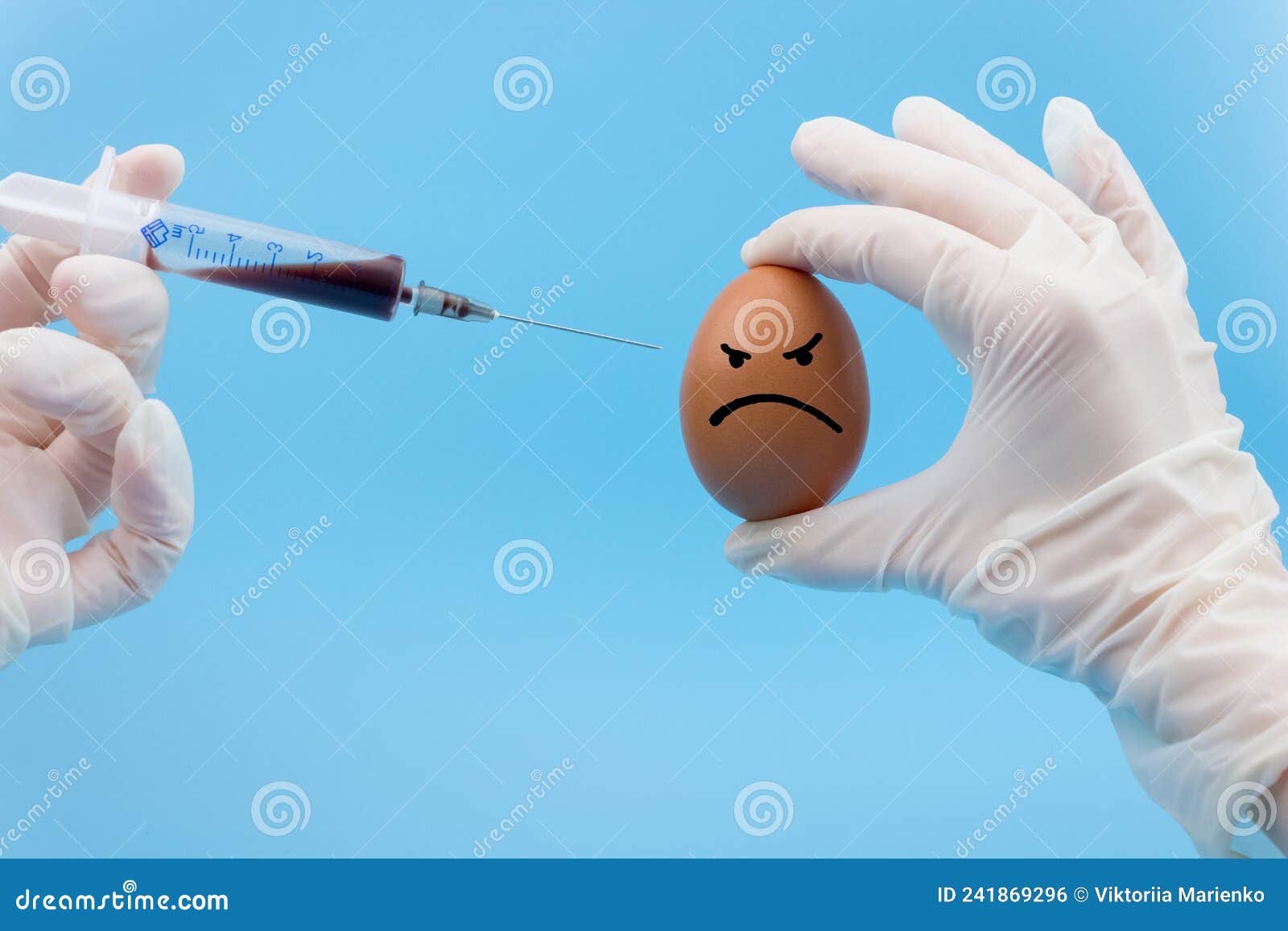 A Hand with a Syringe Makes an Injection into the Egg Close-up. the ...