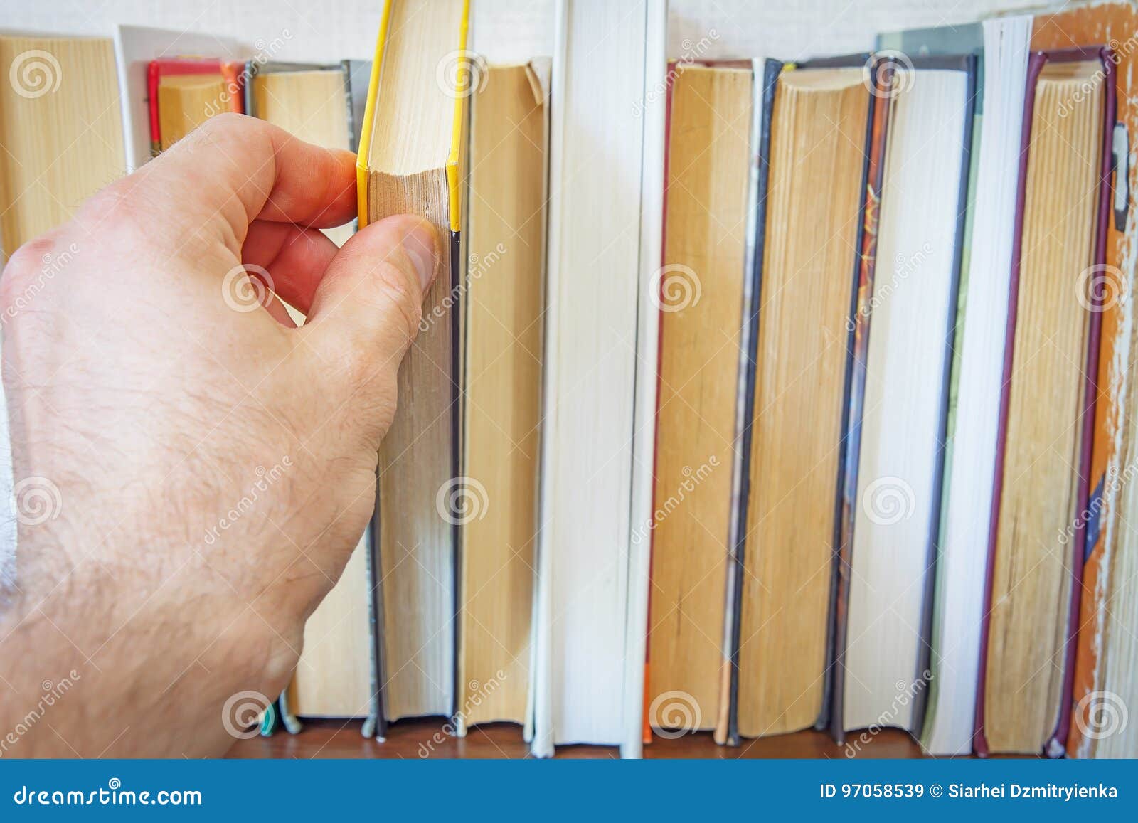Hand Takes Book from Shelf Close-up Stock Image - Image of hand ...