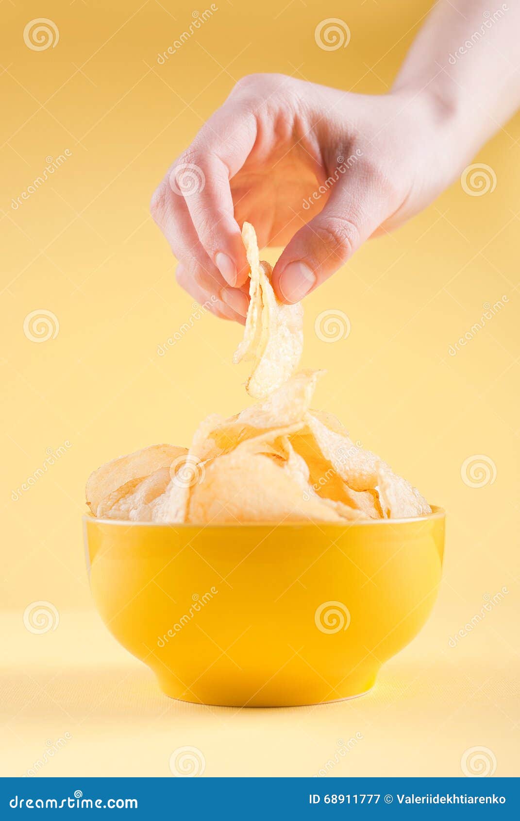 Hand takes potato chips ab stock image. Image of crispy - 68911777