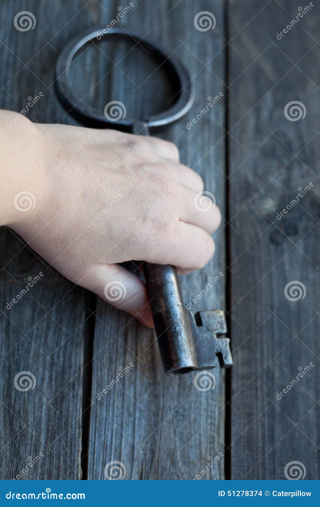 Hand Taking a Big Old Key from Wooden Table Stock Photo - Image of gate ...