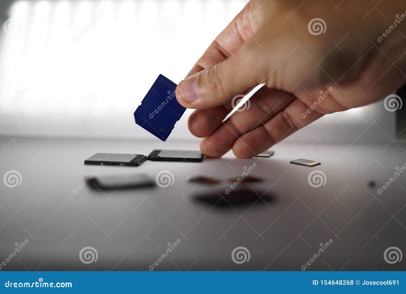 Hand Taking a Blue Memory Card Stock Photo - Image of memory, computer ...