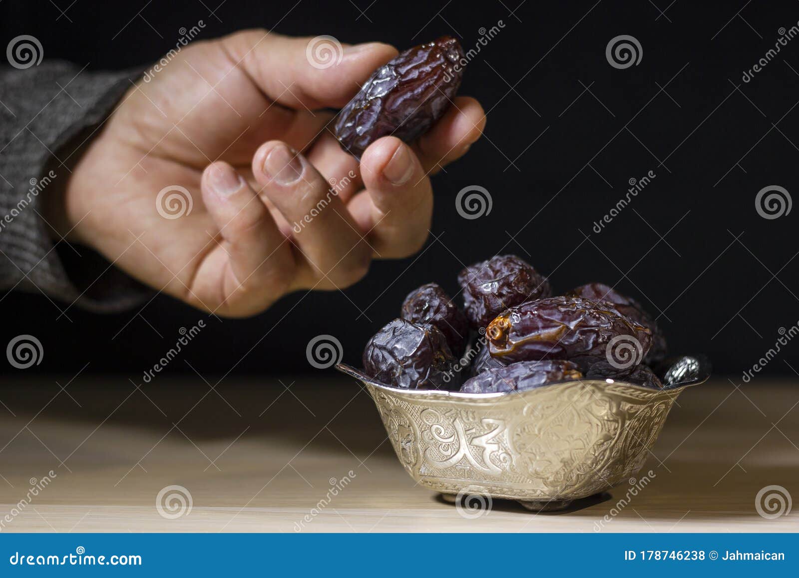 Hand taking the date fruit stock photo. Image of delicious - 178746238