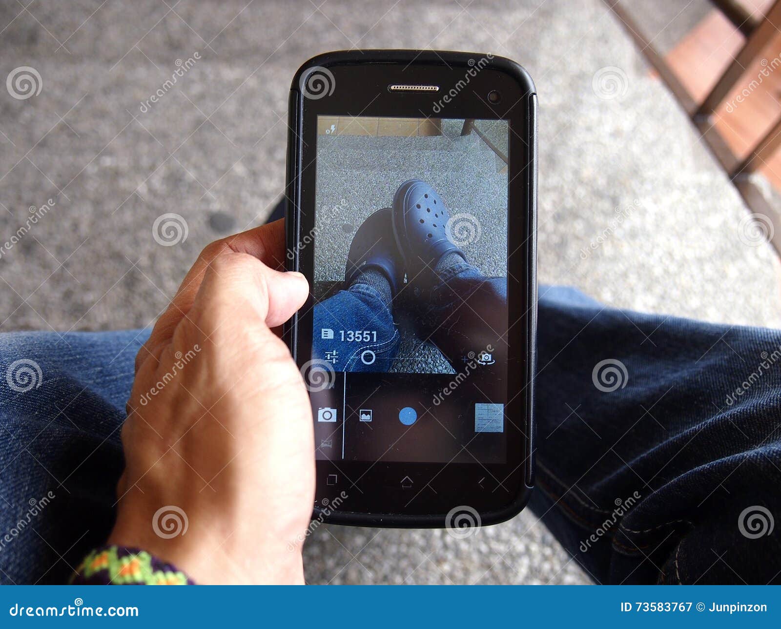 Hand Taking a Photo of Feet Using a Smartphone Stock Image - Image of ...