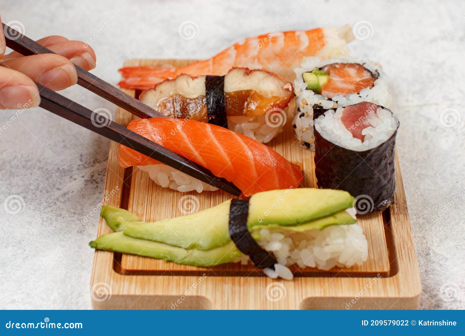 Hand Taking Roll with Chopsticks from a Plate Stock Photo - Image of ...