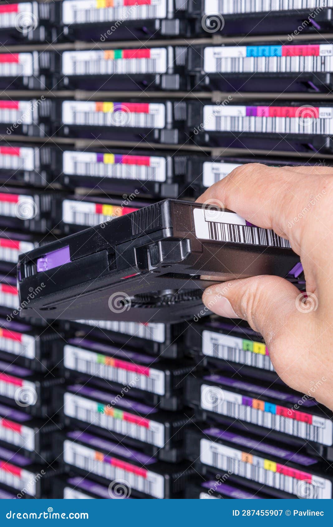 Hand of a Technician Holding Data Storage Magnetic Tape in Front Stock ...