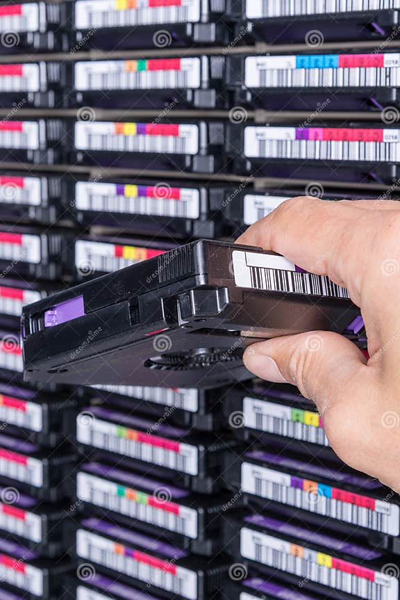 Hand of a Technician Holding Data Storage Magnetic Tape in Front Stock ...