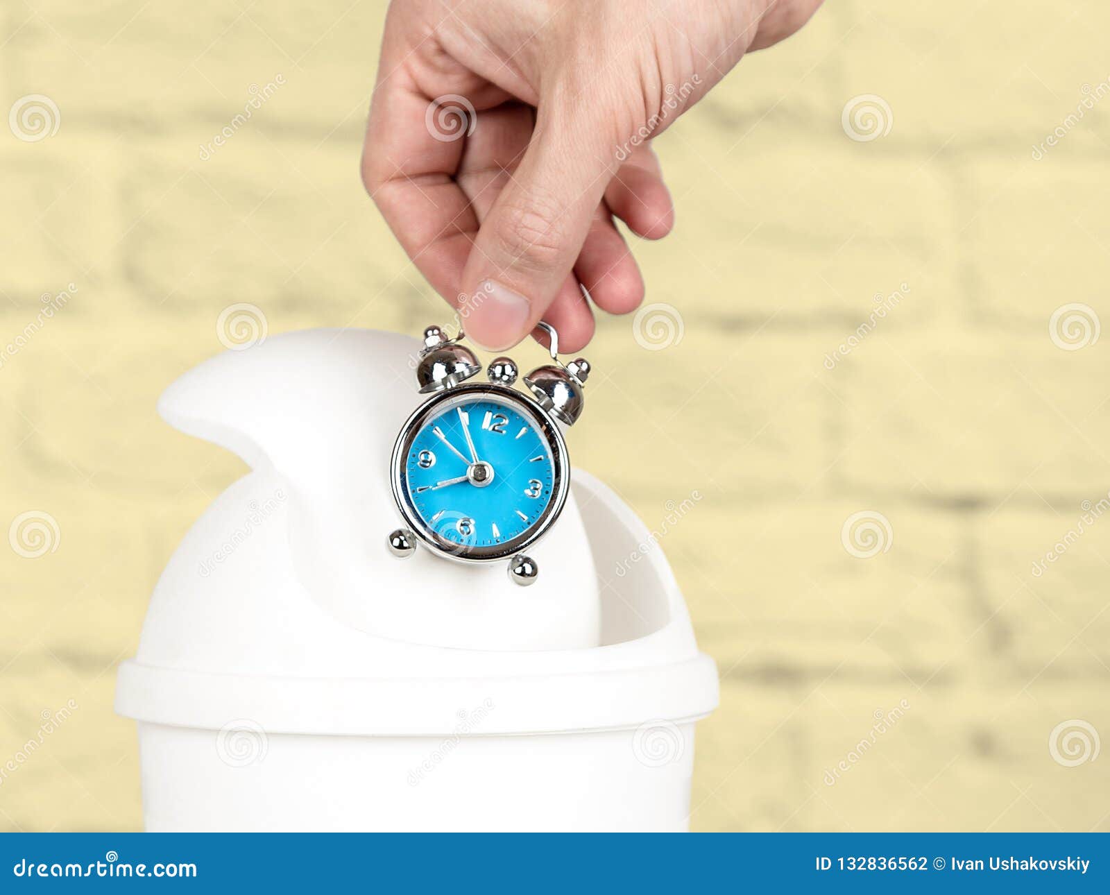 Hand Throwing a Clock into Litter Bin. Waste of Time Concept Stock ...