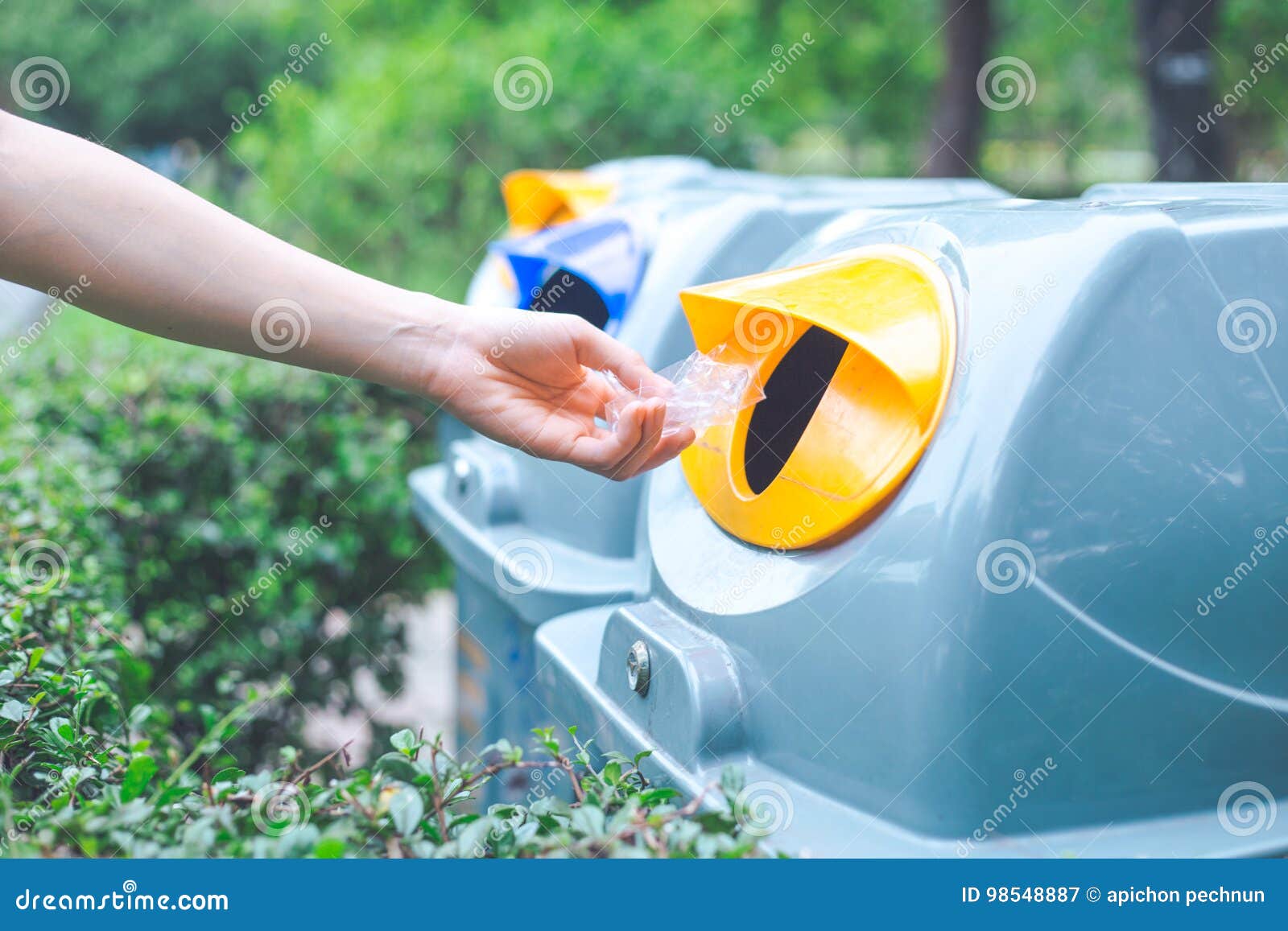 Hand Throwing a Plastic Bag into the Bin.Concepts of Environment Stock ...