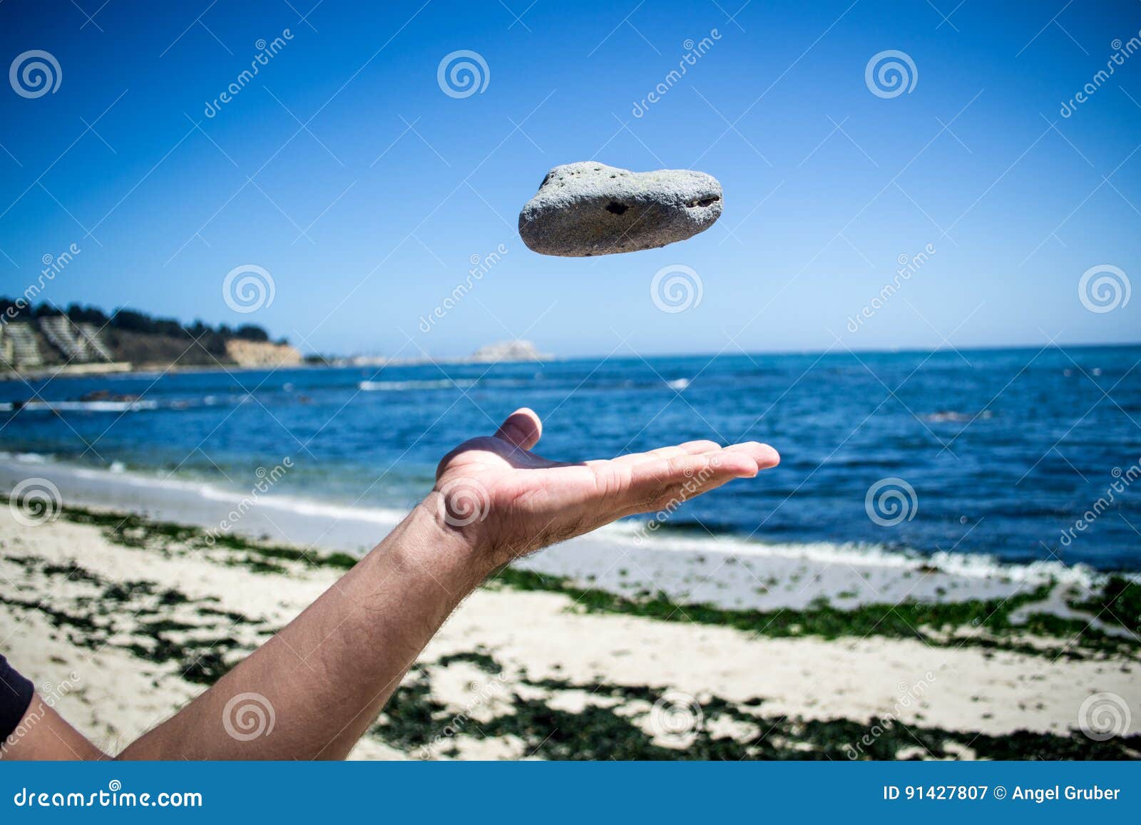 Hand throwing a stone stock image. Image of background - 91427807