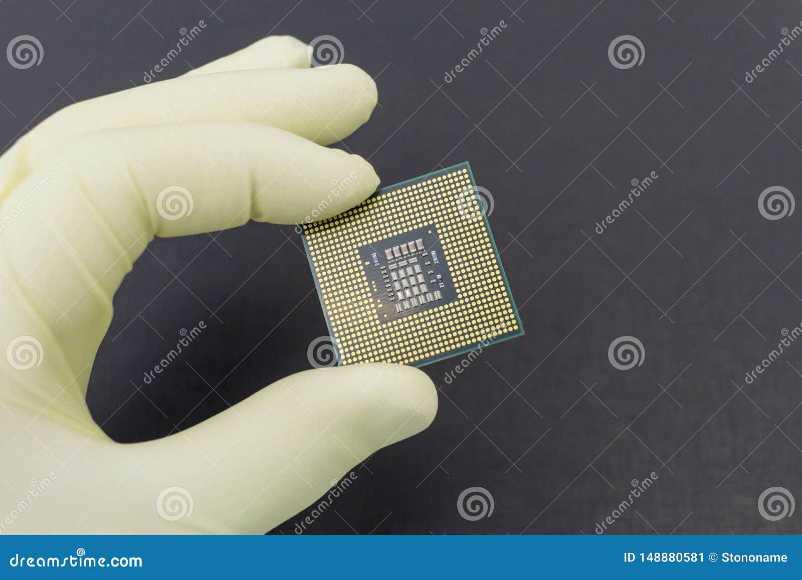 Hand in Tight Yellow Glove Holding a CPU Computer Processor Microchip ...