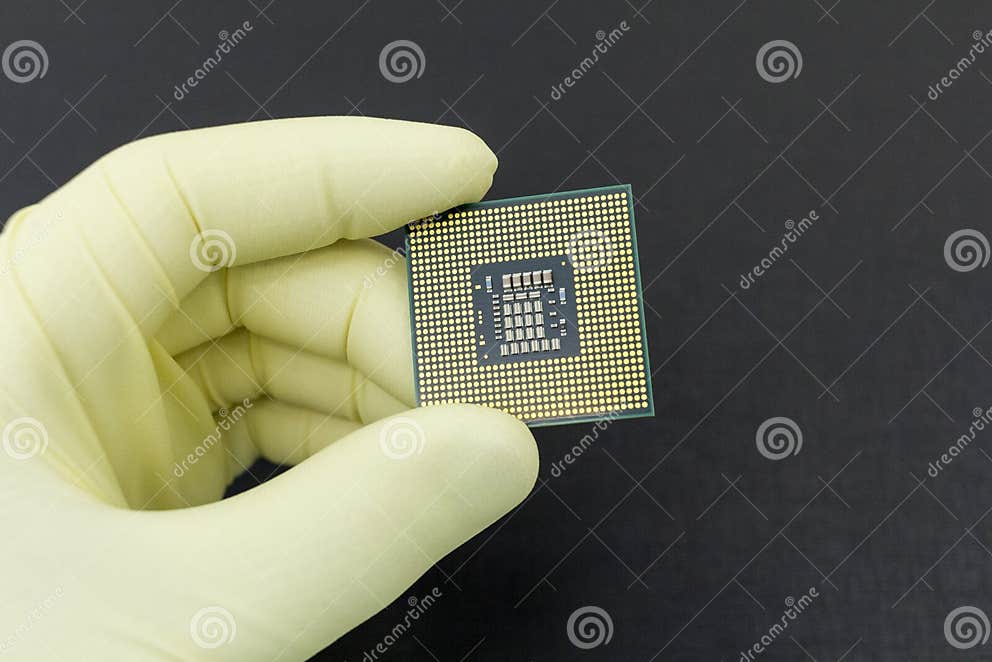 Hand in Tight Yellow Glove Holding a CPU Computer Processor Microchip ...