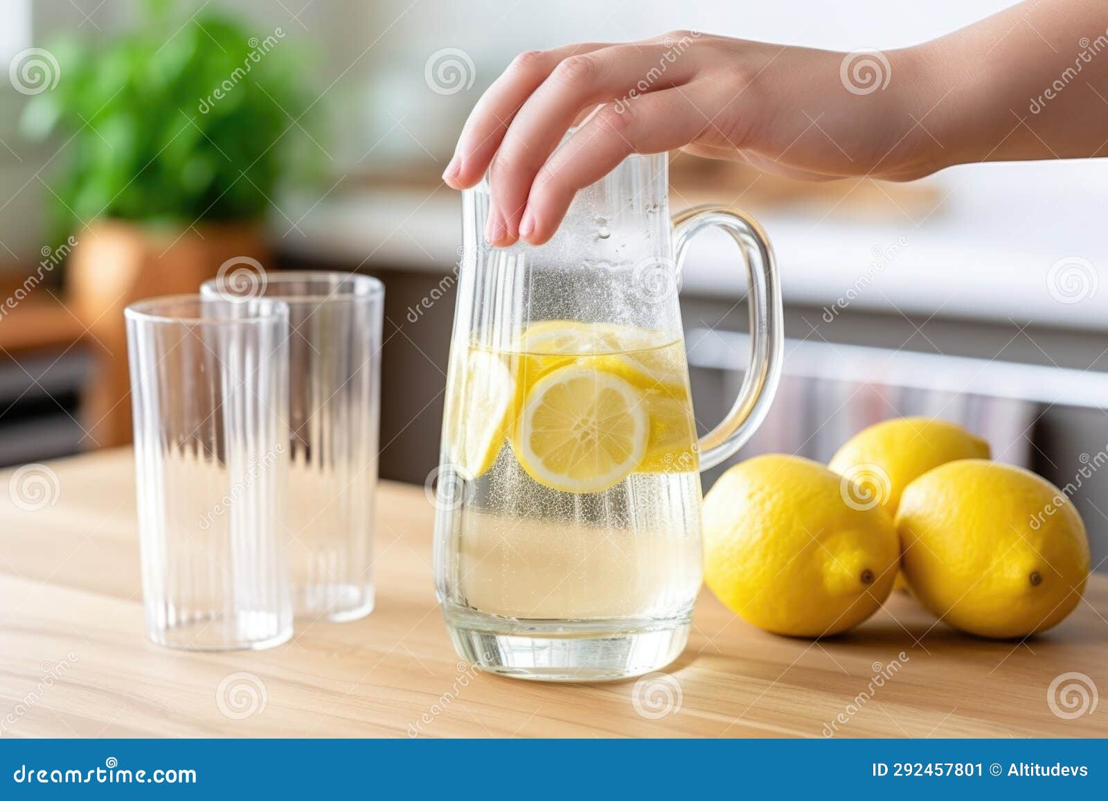 Hand Topping Up a Pitcher of Lemonade with Soda Water Stock ...