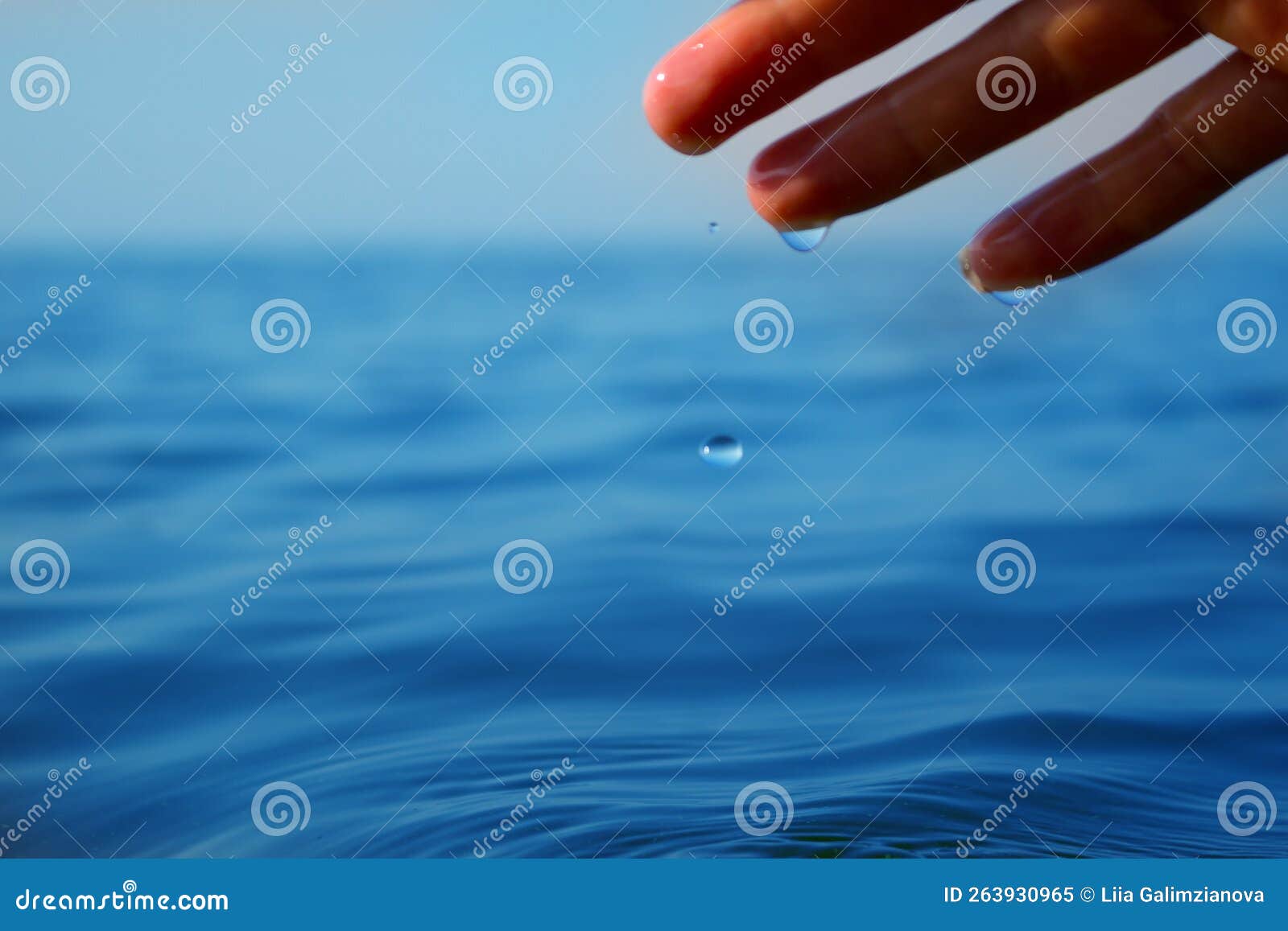 Hand touching the water stock image. Image of travel - 263930965