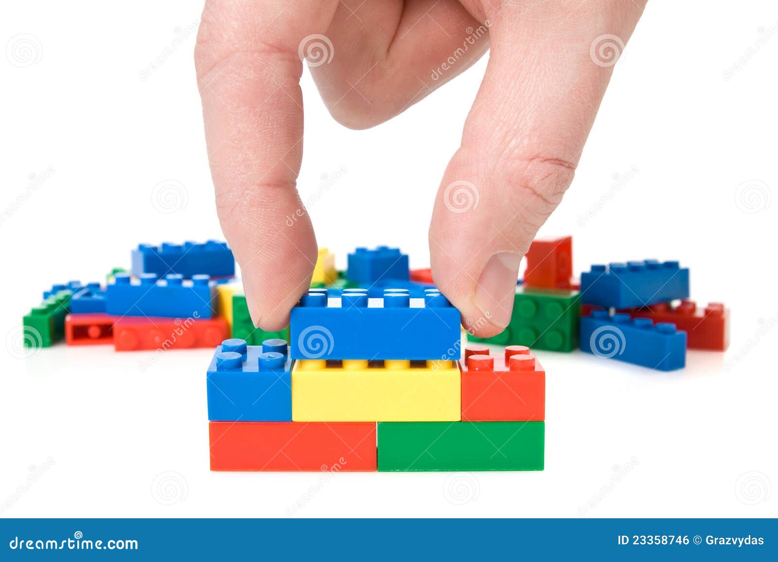 Hand and toy blocks stock photo. Image of playing, bricks - 23358746