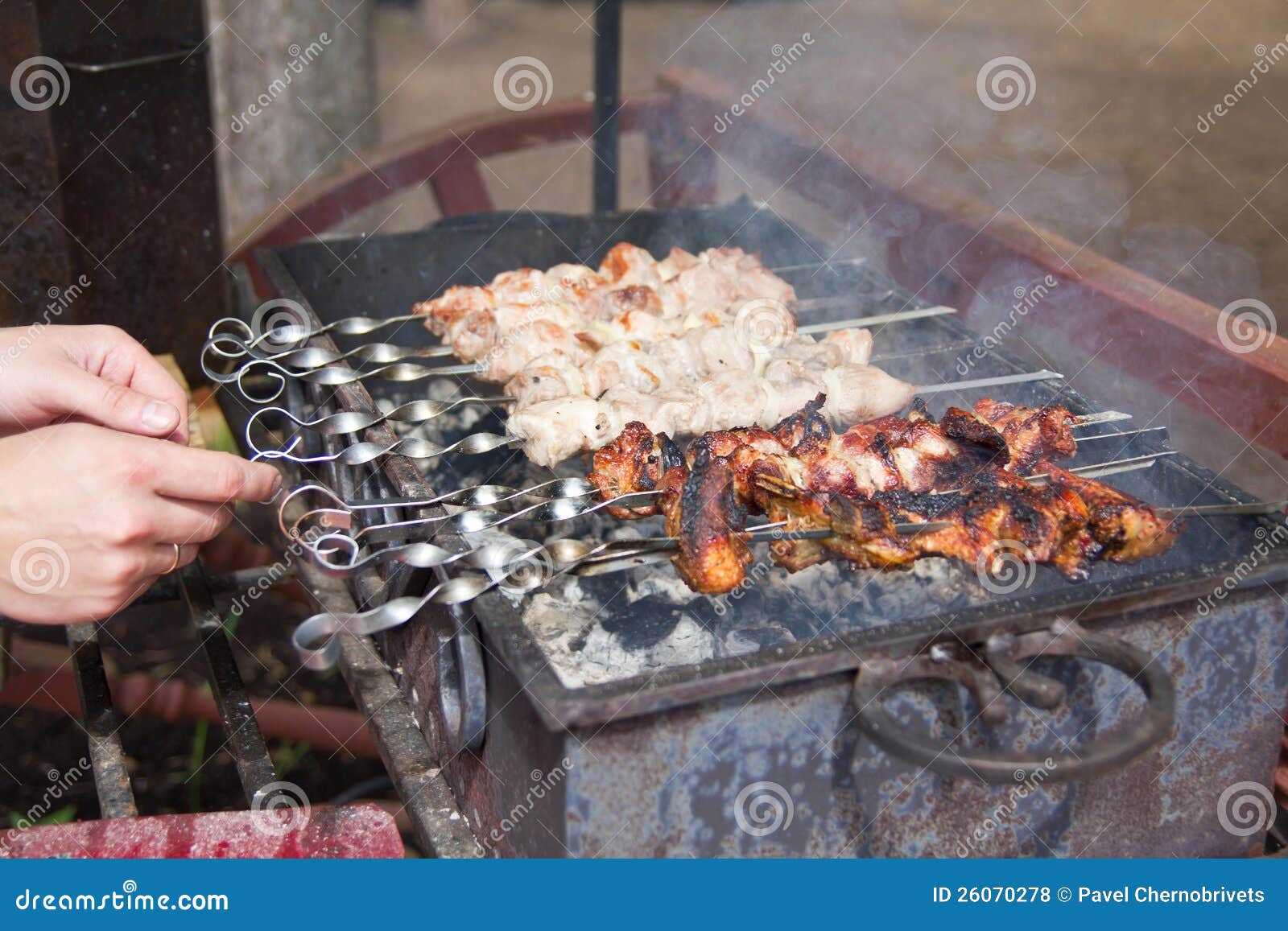 Hand turning skewer stock photo. Image of dinner, hand - 26070278