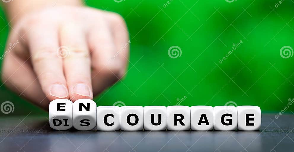 Hand Turns Dice and Changes the Word Discourage To Encourage. Stock ...