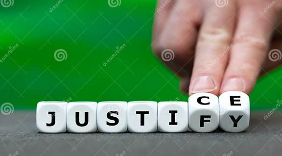 Hand Turns Dice and Changes the Word Justify To Justice. Stock Image ...