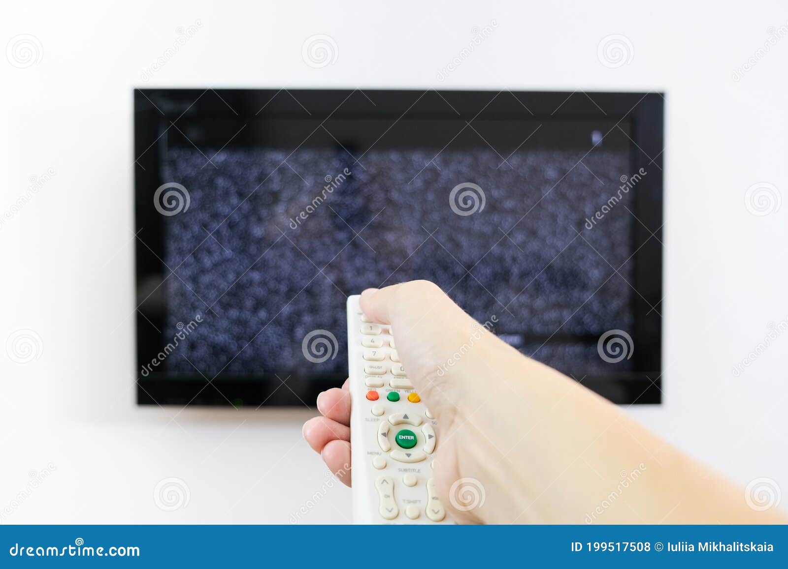 Hand with TV Remote Control in Front of the Screen with White Noise on ...