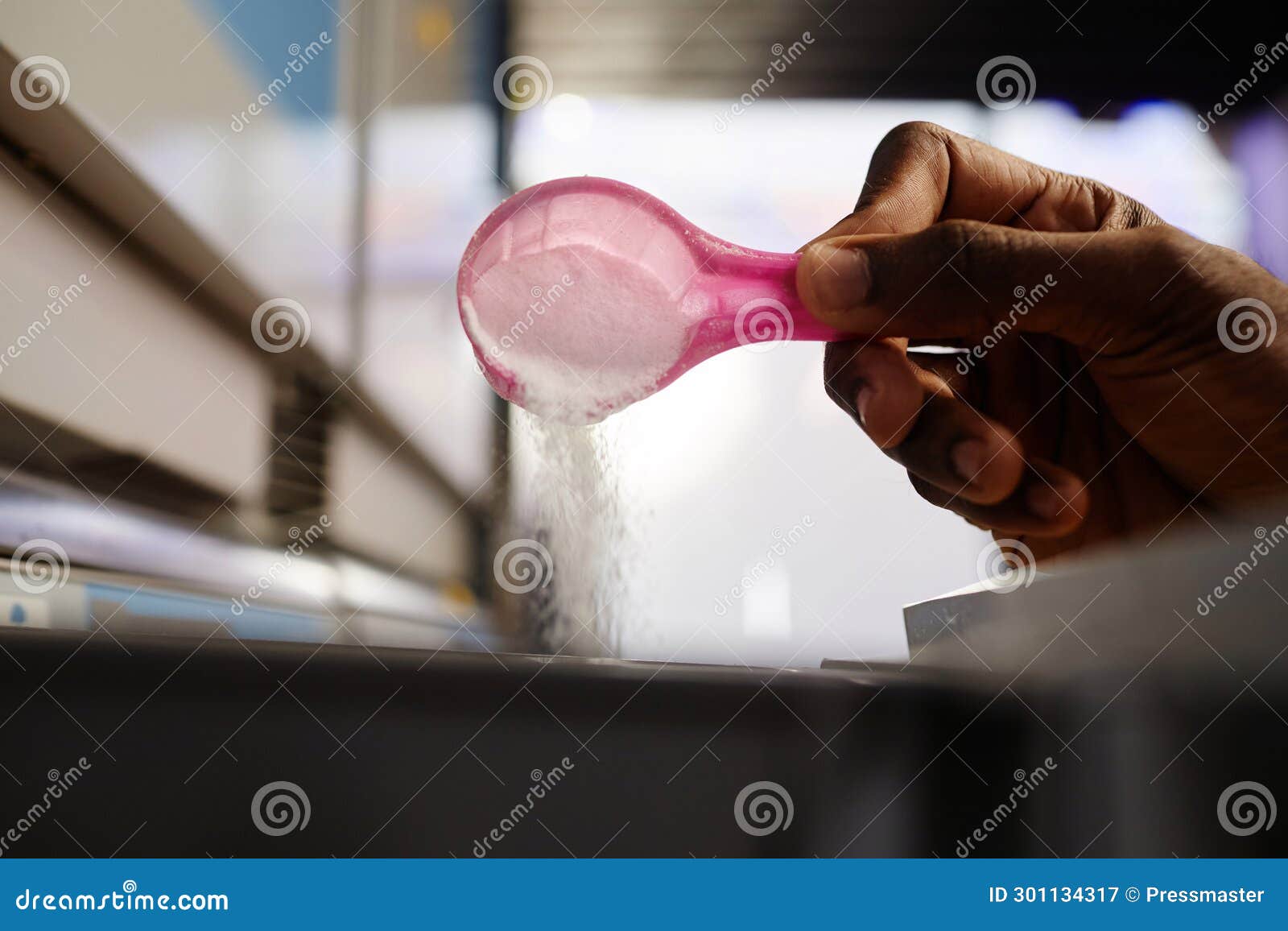 Hand of Unrecognizable Young Man Pouring Soap Powder into Compartment ... Hand of Unrecognizable Young Man Pouring Soap Powder into Compartment ...