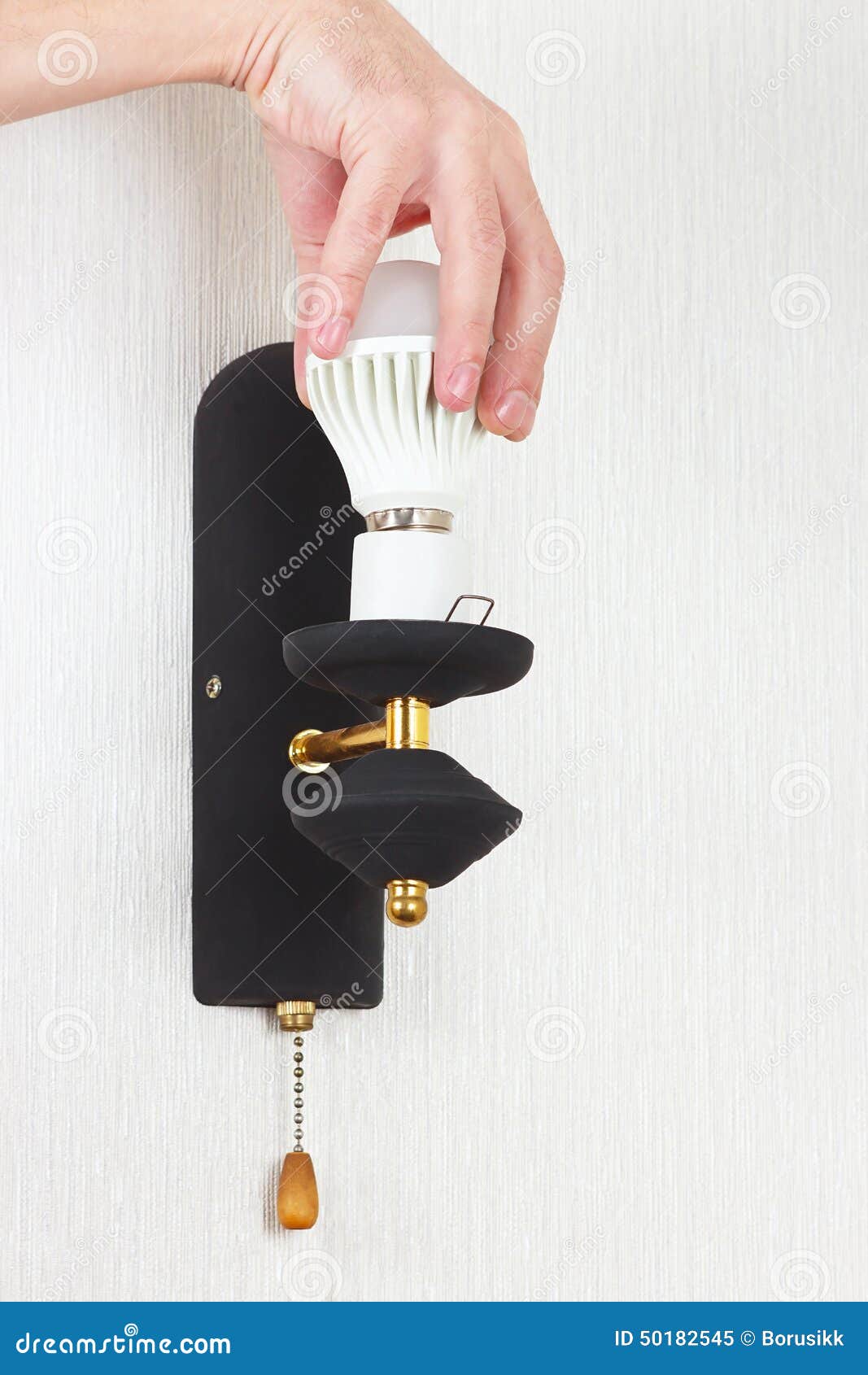 Hand Unscrews Led Bulb in a Lamp on White Wall Stock Image - Image of ...