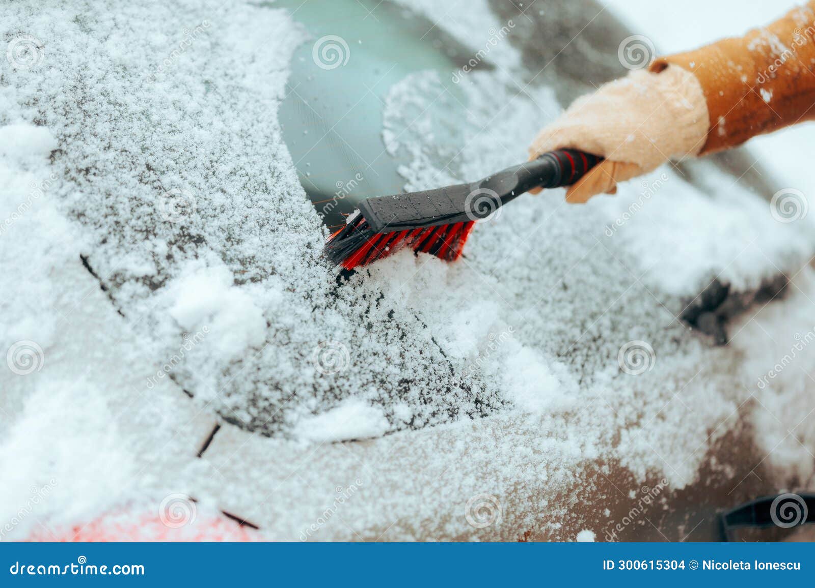 Person Wiping Snow from a Windshield with a Brush Stock Photo - Image ...