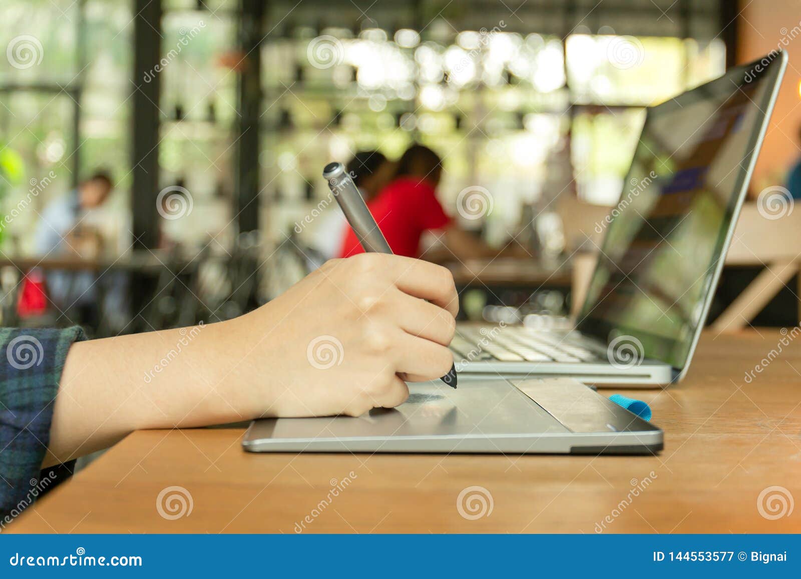 Hand Using Digital Tablet and Stylus Penand Working on Laptop Computer ...