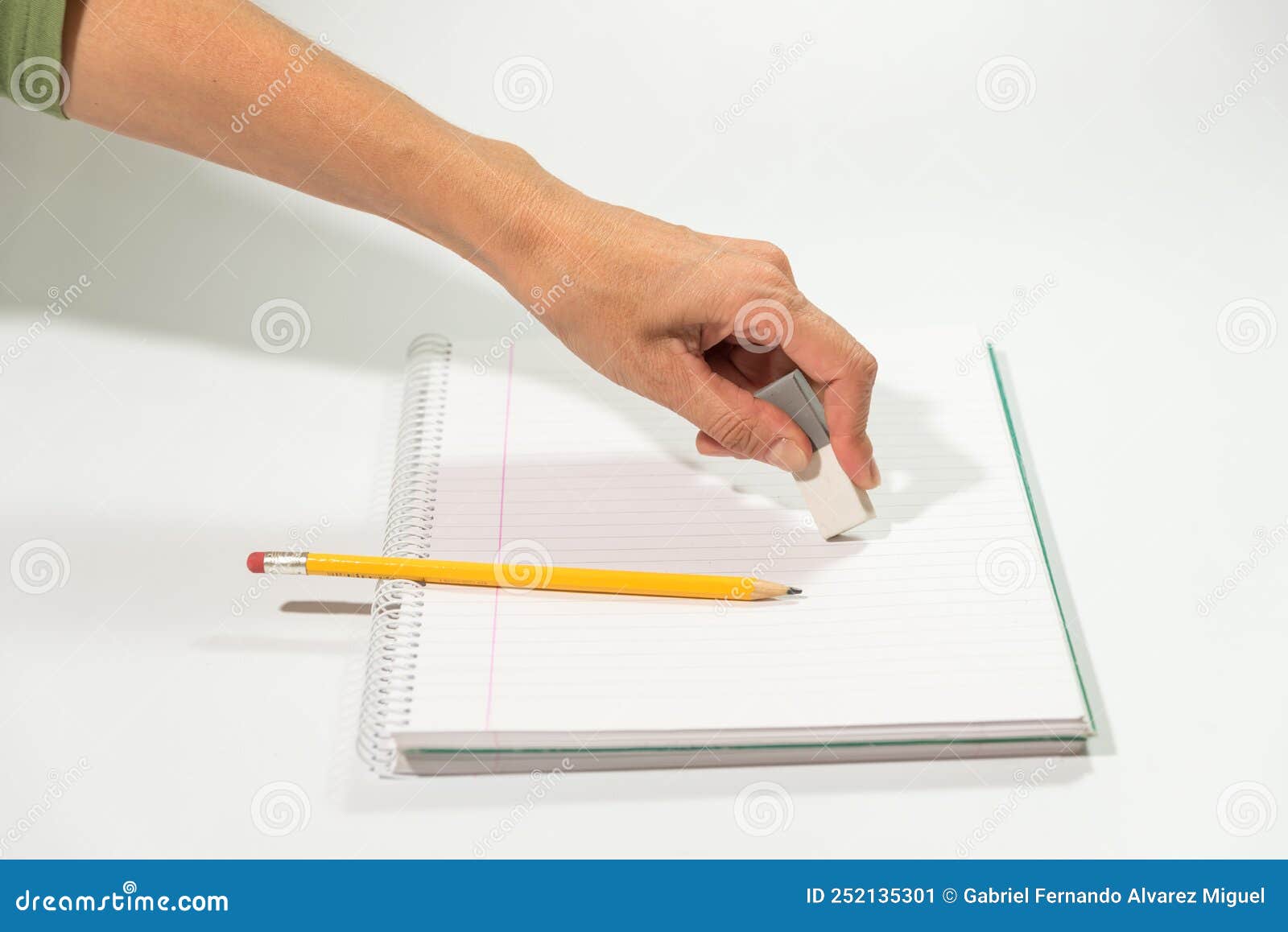 Hand Using an Eraser on a Notebook, Pencil on the Table Stock Image ...
