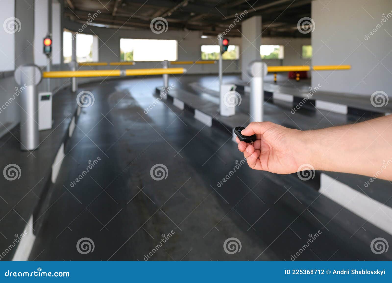 A Hand Using a Remote Control Opens an Automatic Barrier in a Parking ...