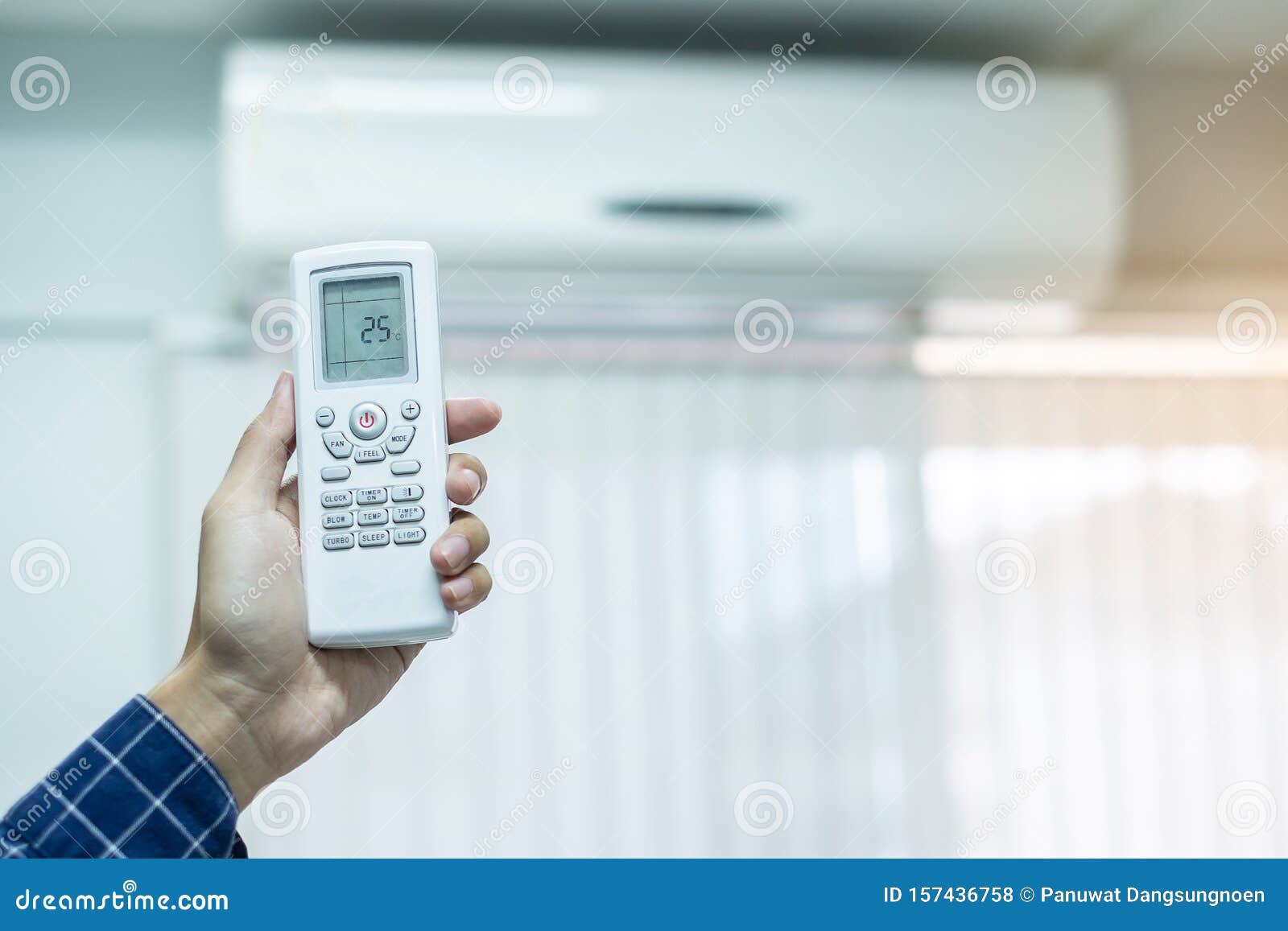 Hand Using Remote Controller for Adjust Air Conditioner Inside the Room ...