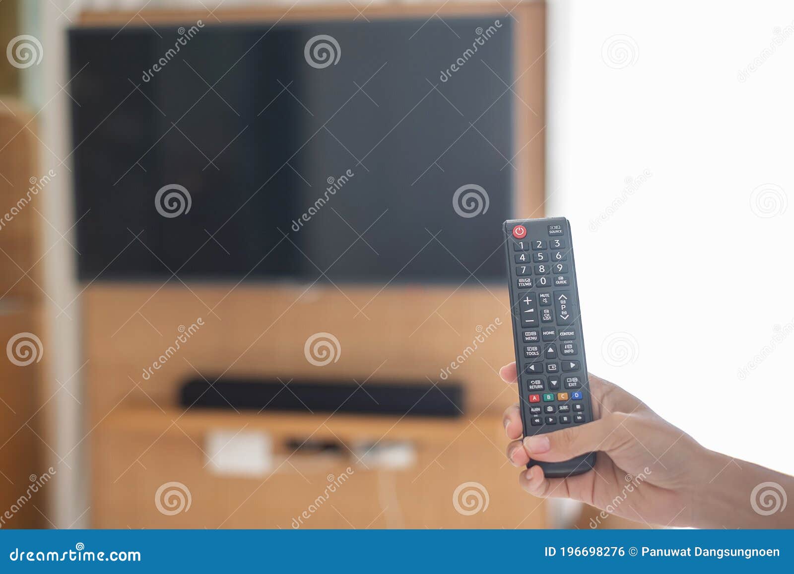 Hand Using Remote Controller for Adjust Smart TV Inside the Modern Room ...