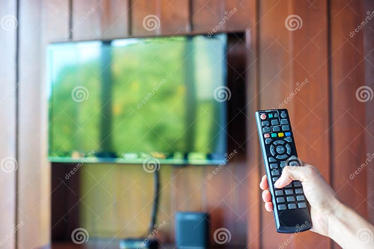 Hand Using Remote Controller for Adjust Smart TV Inside the Modern Room ...
