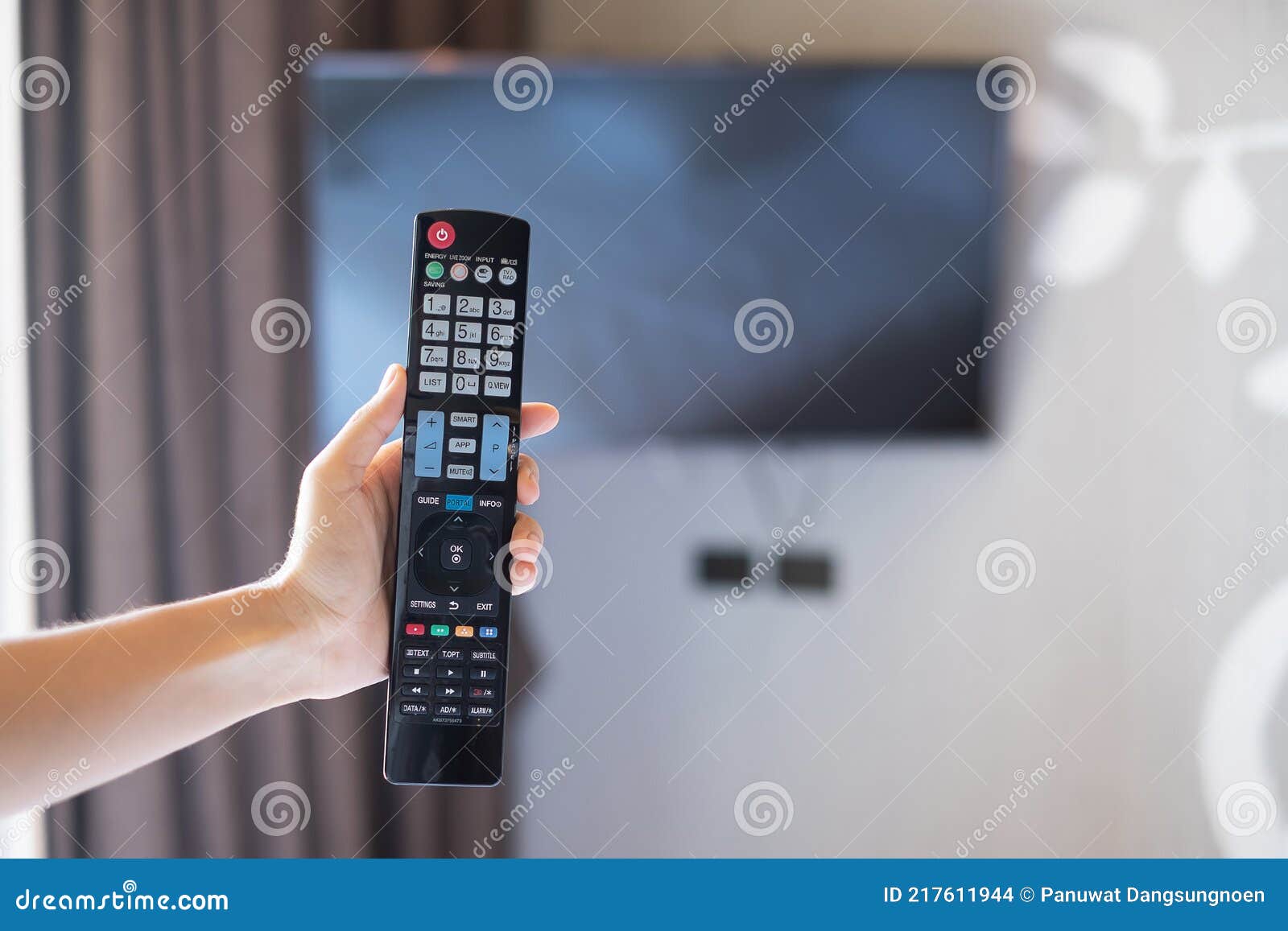 Hand Using Remote Controller for Adjust Smart TV Inside the Modern Room ...