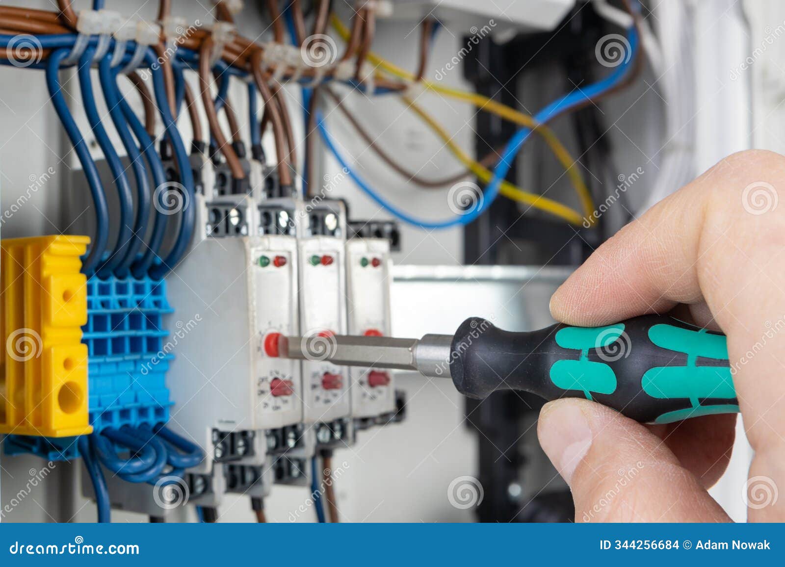 Hand Using Screwdriver on Electrical Terminal Block Stock Photo - Image ...