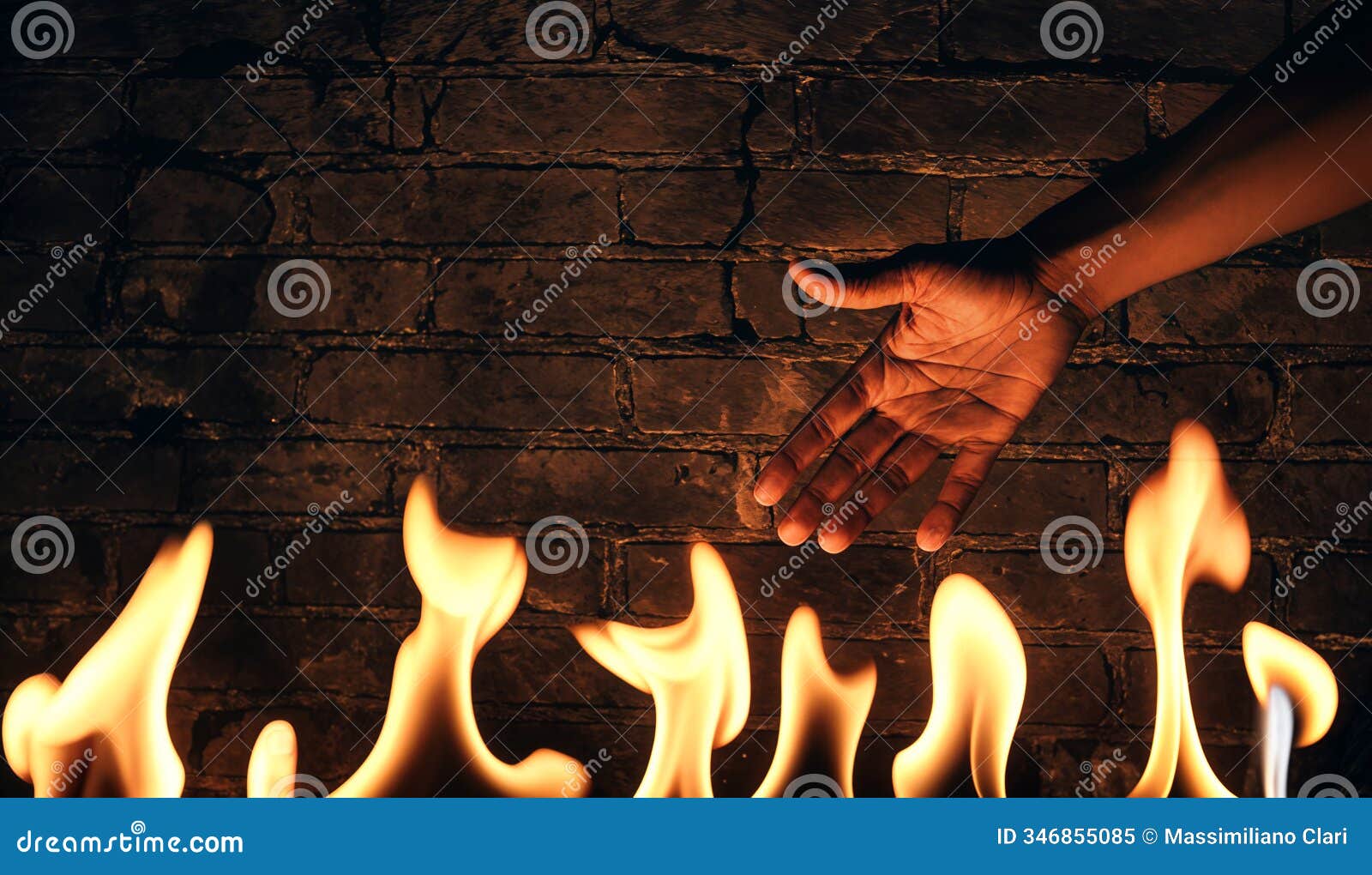 Hand Warming by Firelight in Front of Brick Wall Background Stock ...