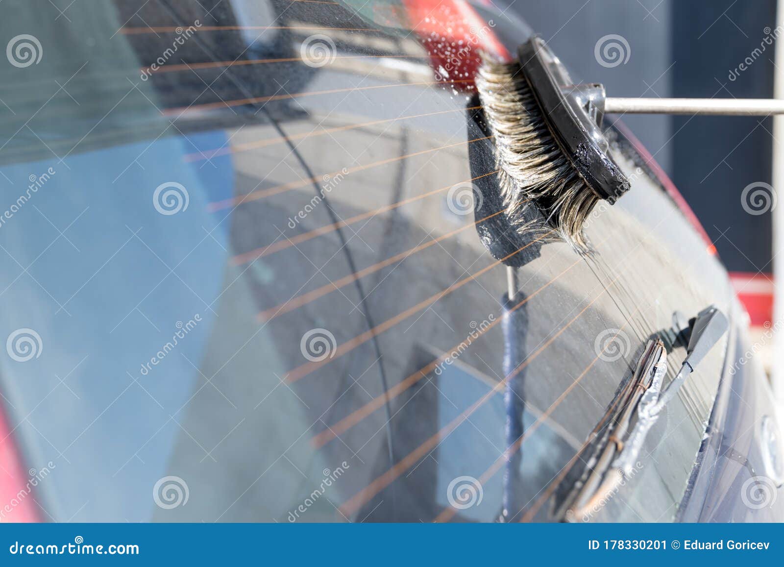 Hand Wash the Rear Window of the Car Using Brush and Water with Shampoo ...