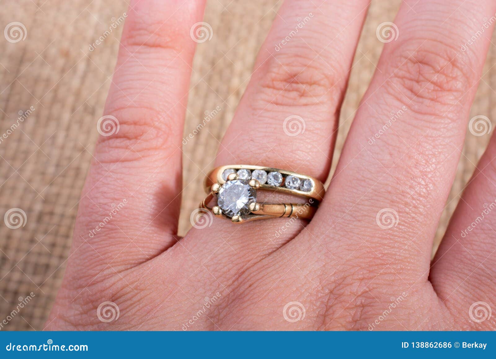 Hand Wearing a Diamond Ring on a Textured Background Stock Photo ...
