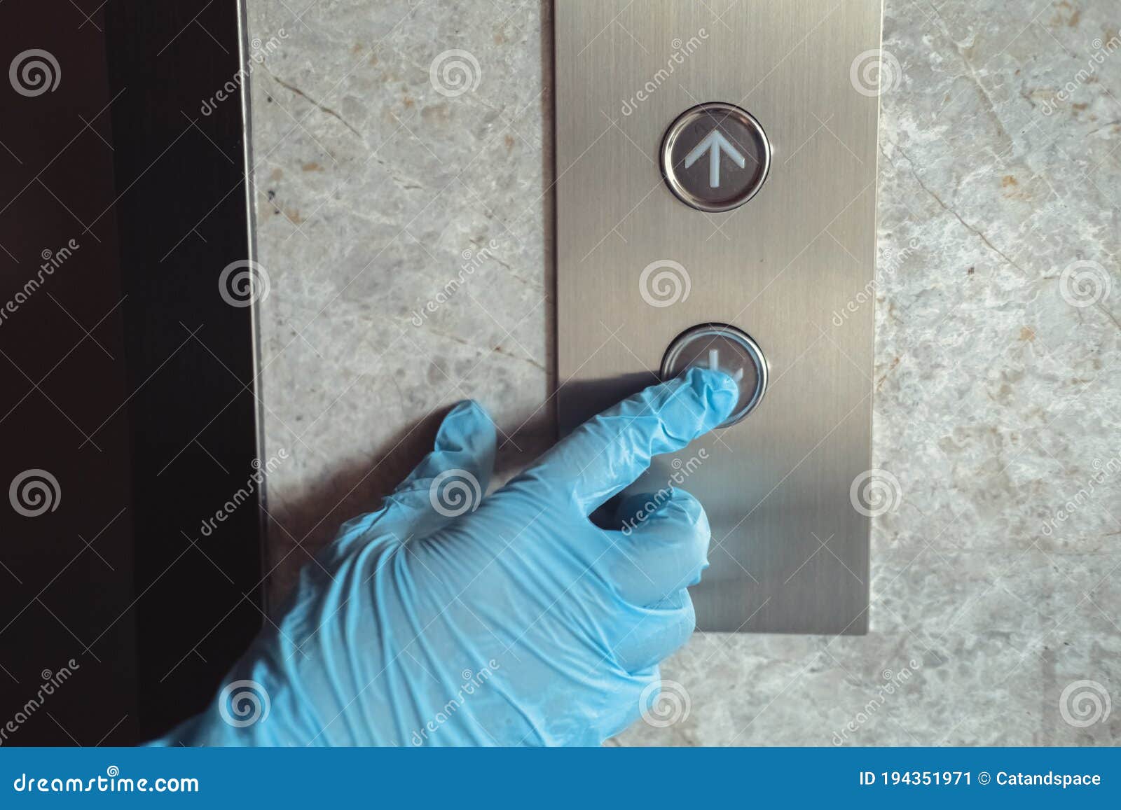 A Hand Wearing Protective Rubber Gloves is Pressing Elevator Button ...